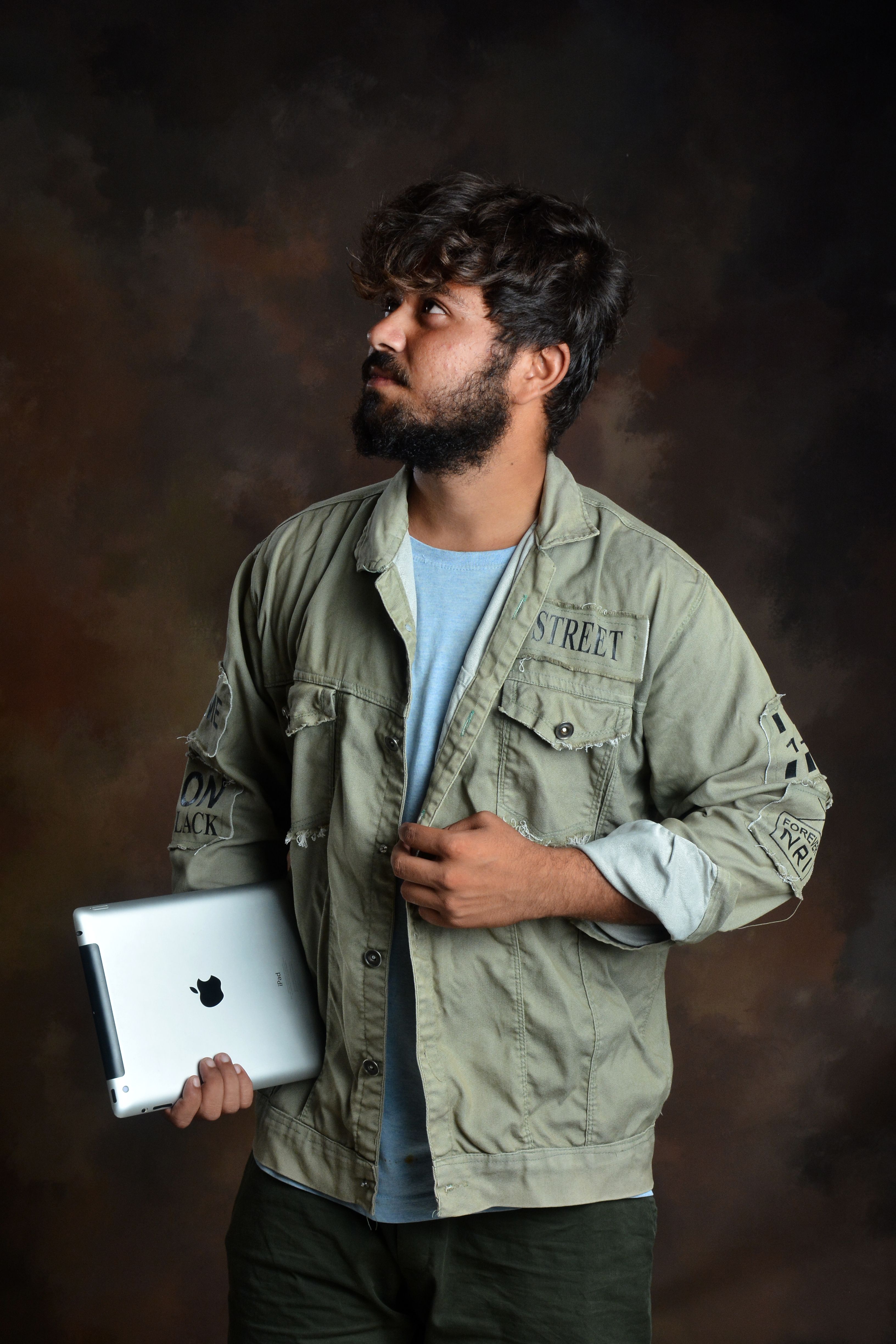 Man Standing and Holding a Tablet · Free Stock Photo