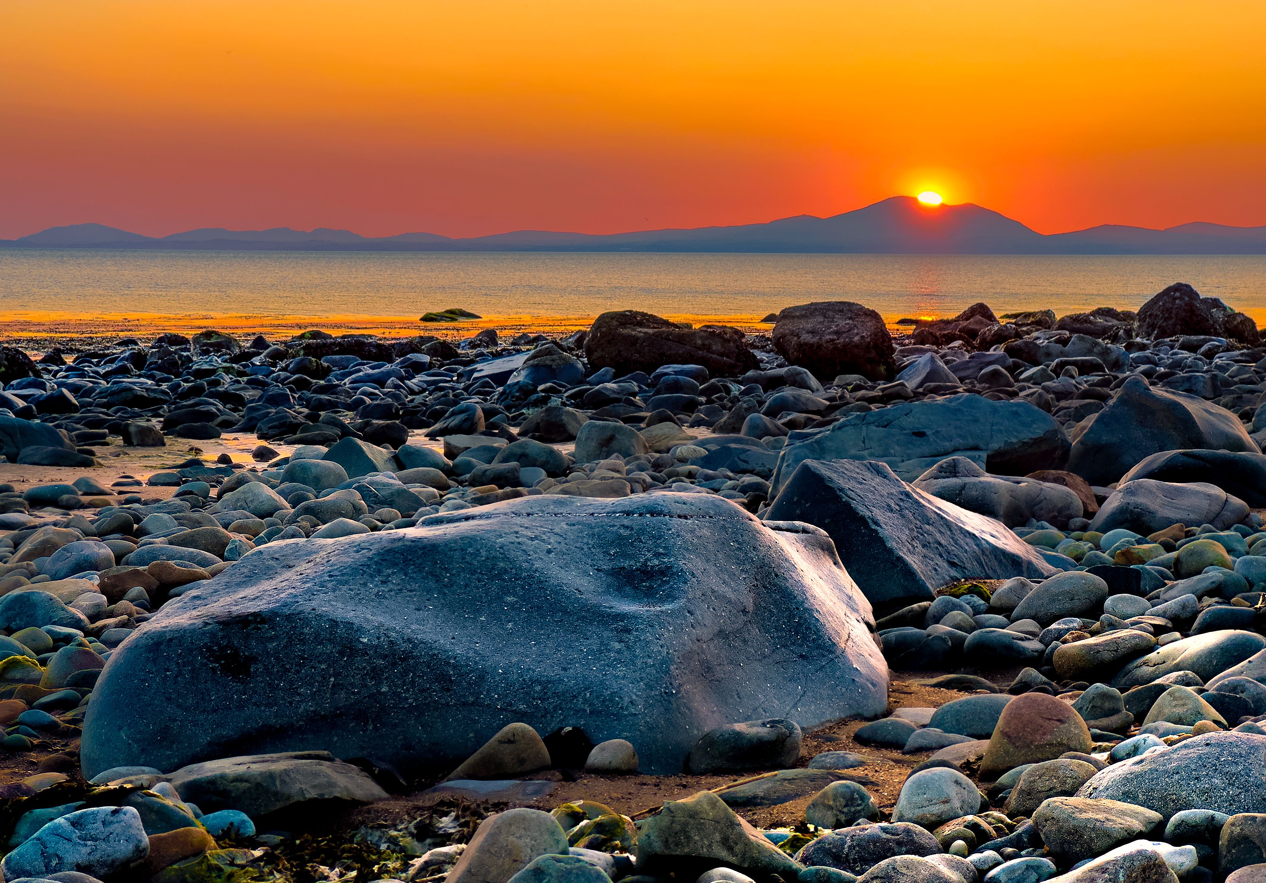 Rocks on a Scenic Beach at Sunset · Free Stock Photo