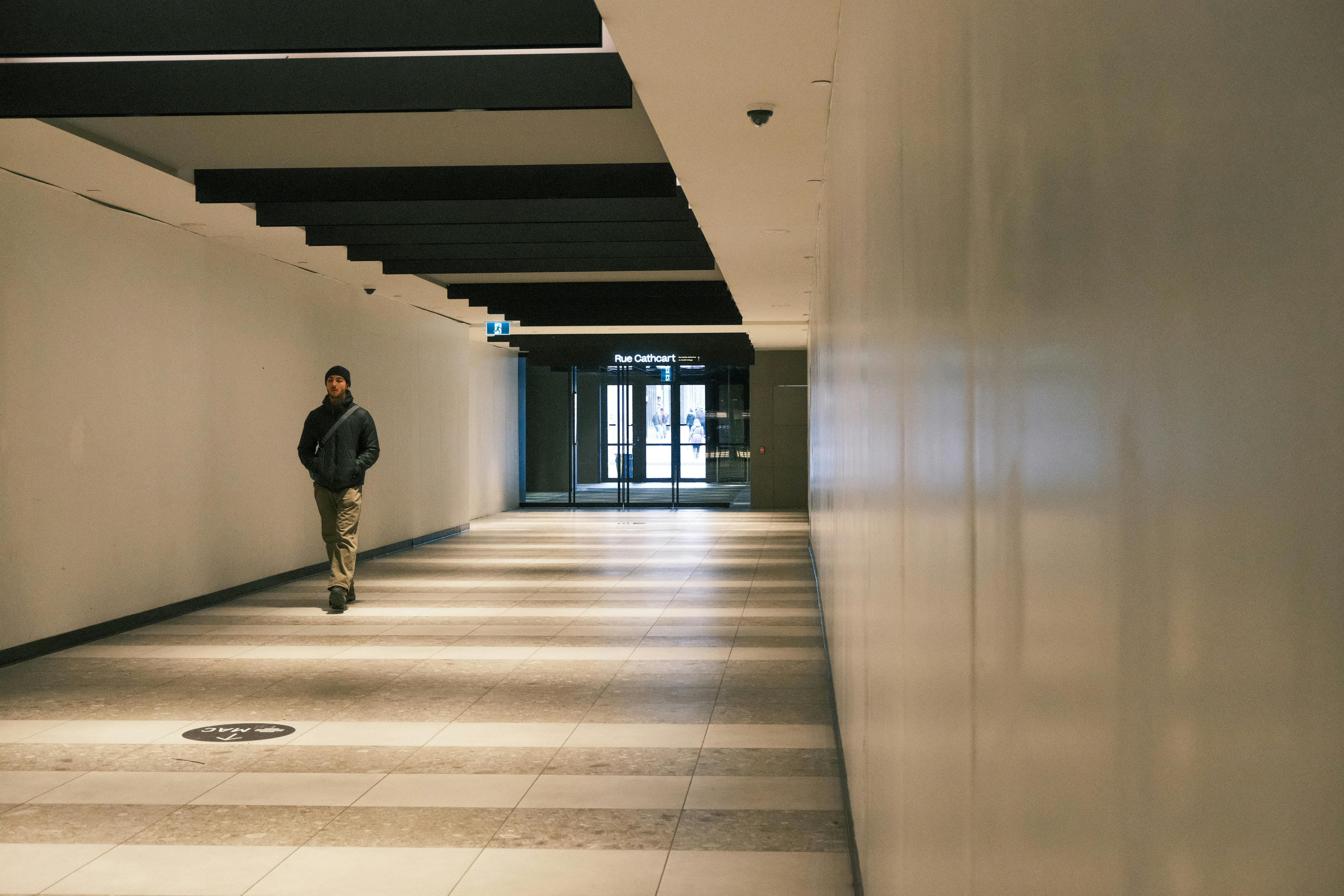 Man Walking down a Corridor · Free Stock Photo