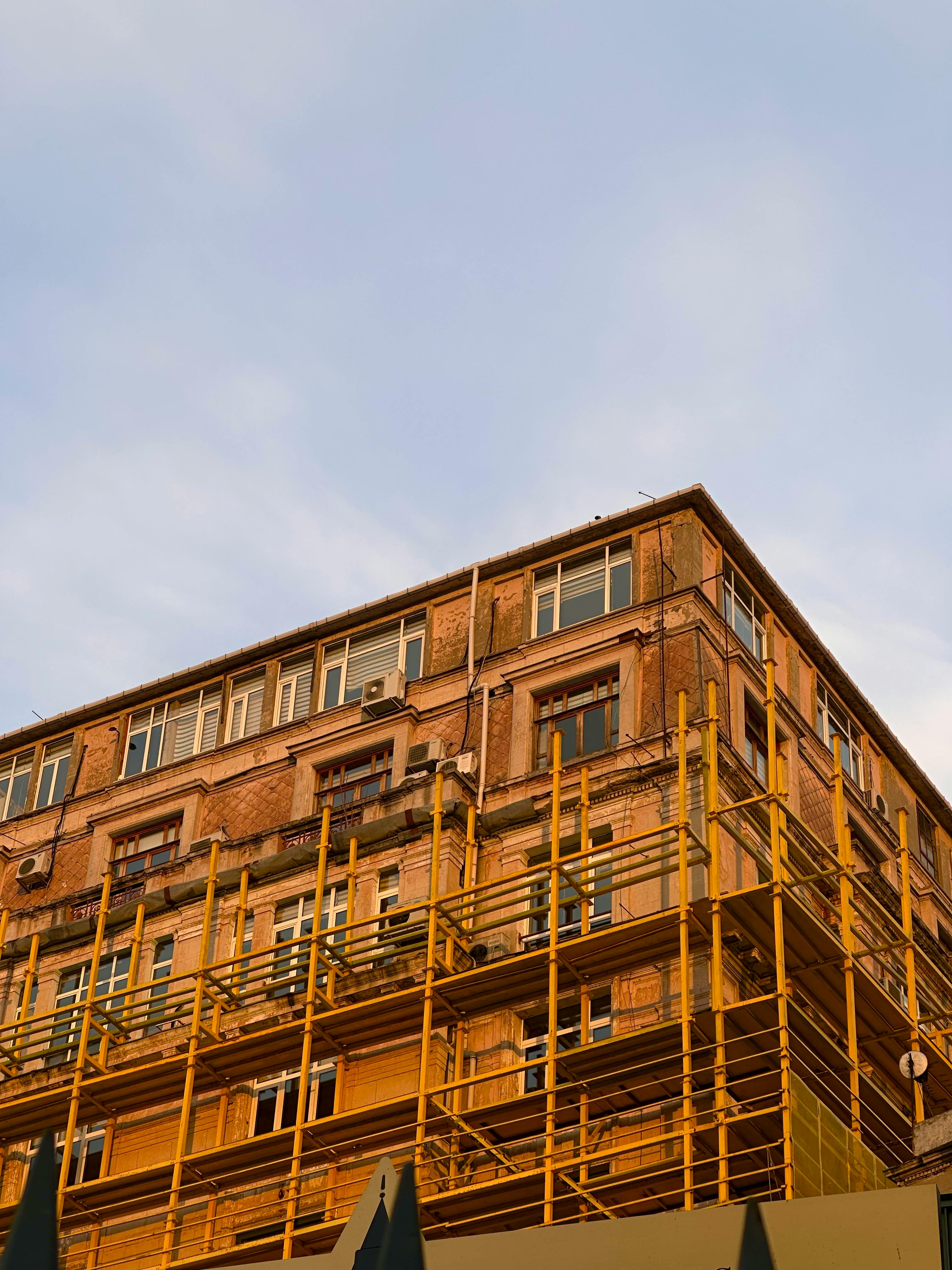 Yellow Scaffolding Surround Residential Building · Free Stock Photo