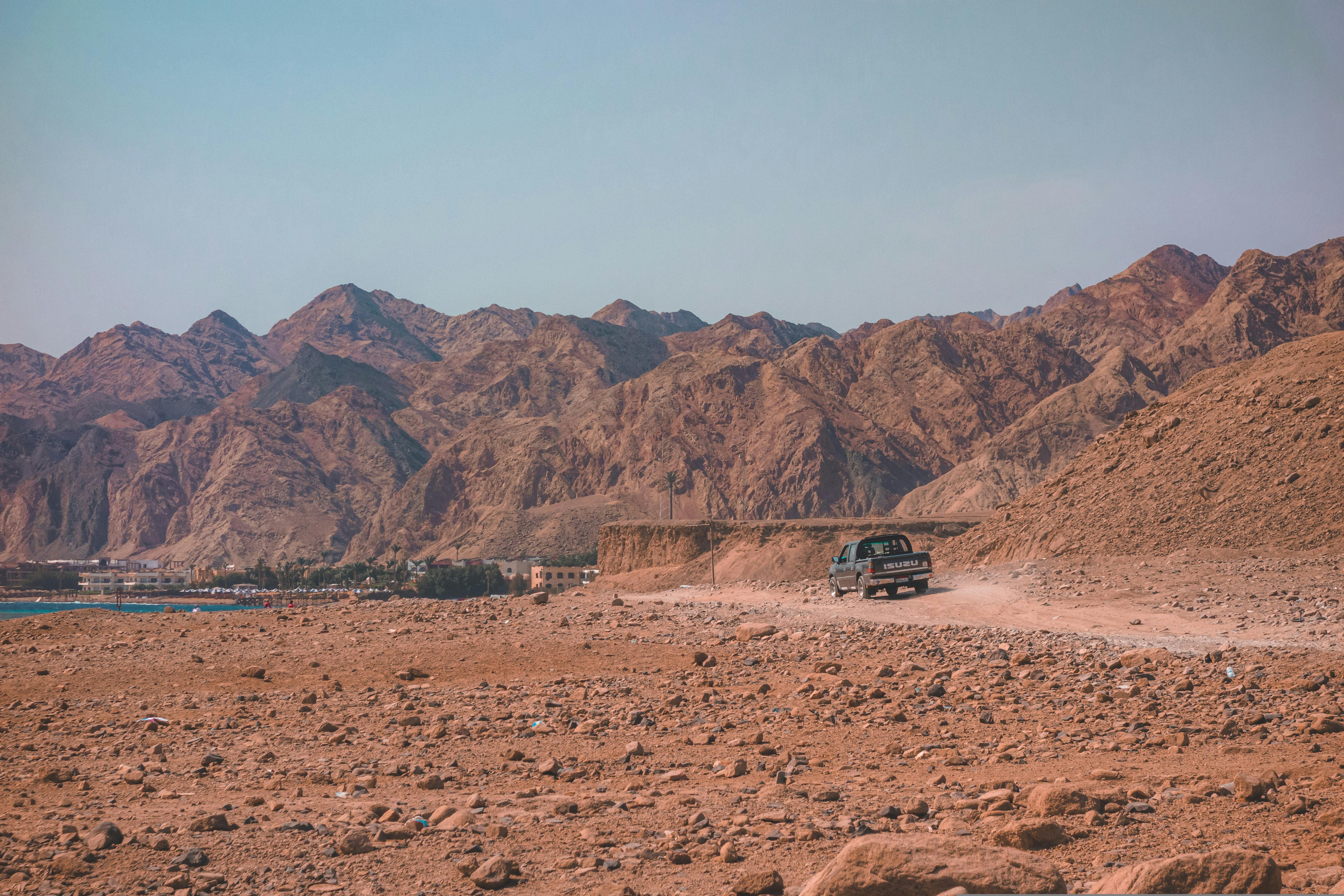 A Car Driving on the Road in the Desert · Free Stock Photo