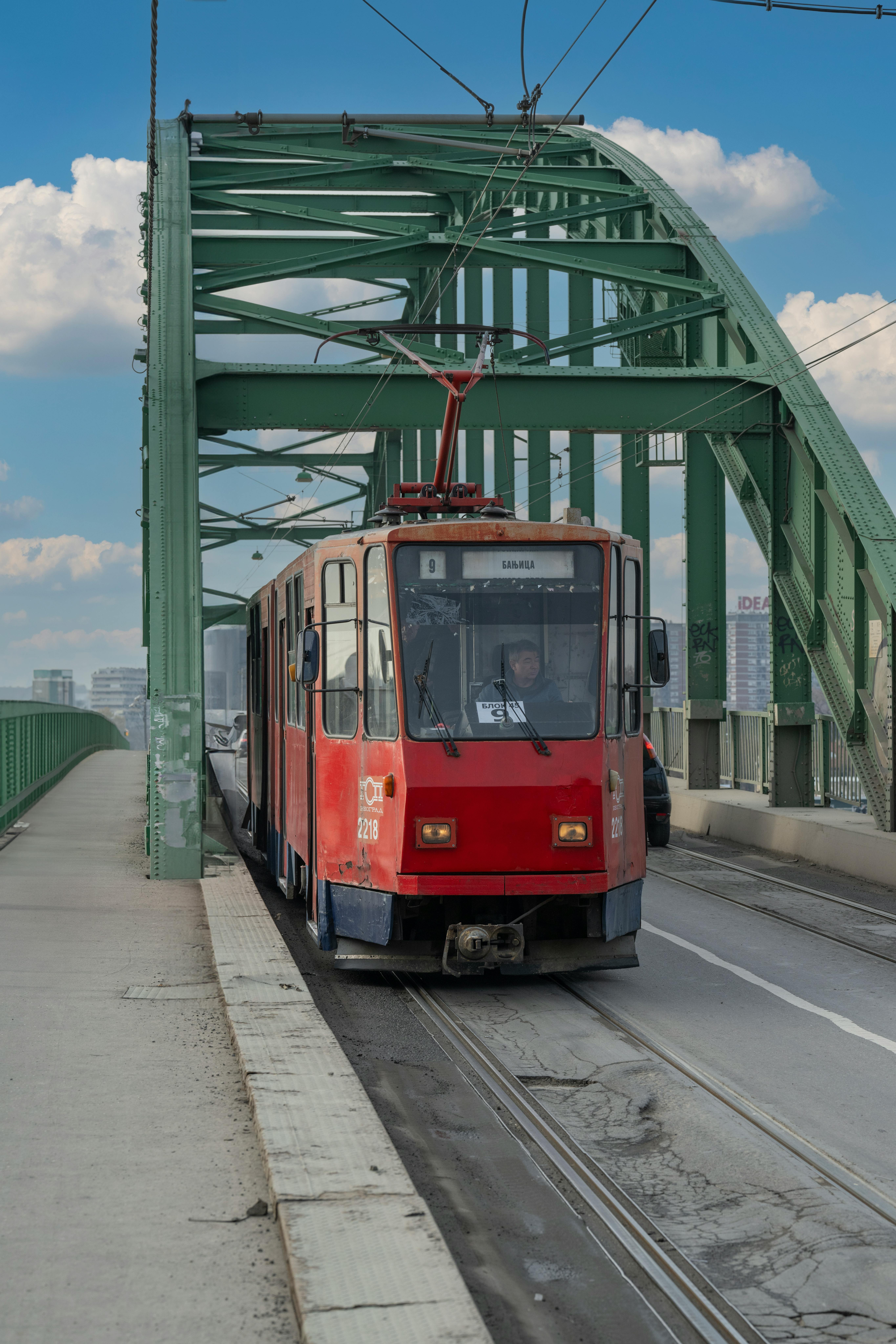 Red Tram on a Suspension Bridge · Free Stock Photo