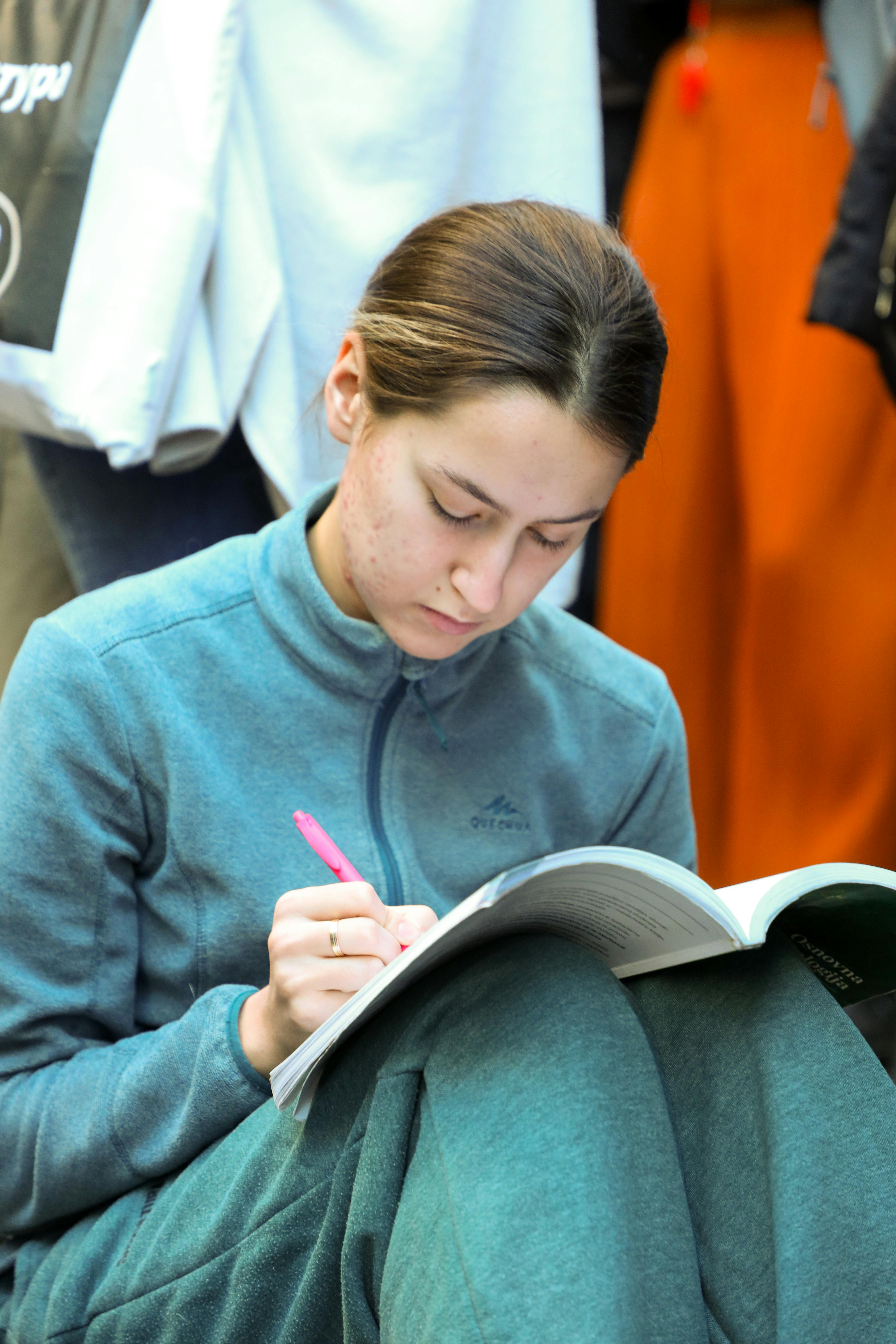 A Woman Sitting and Writing · Free Stock Photo