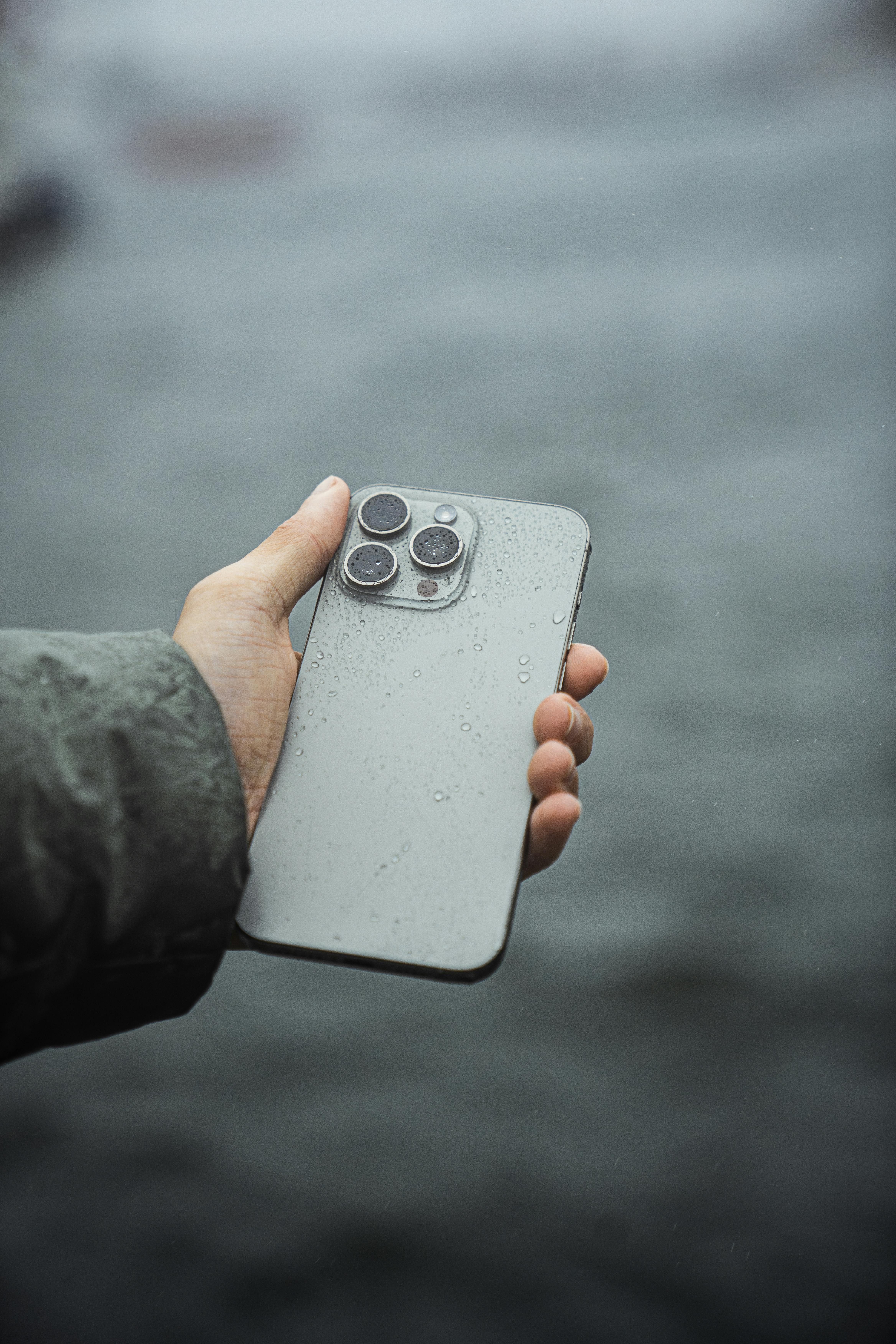 Photo of Person Holding Wet Smartphone · Free Stock Photo