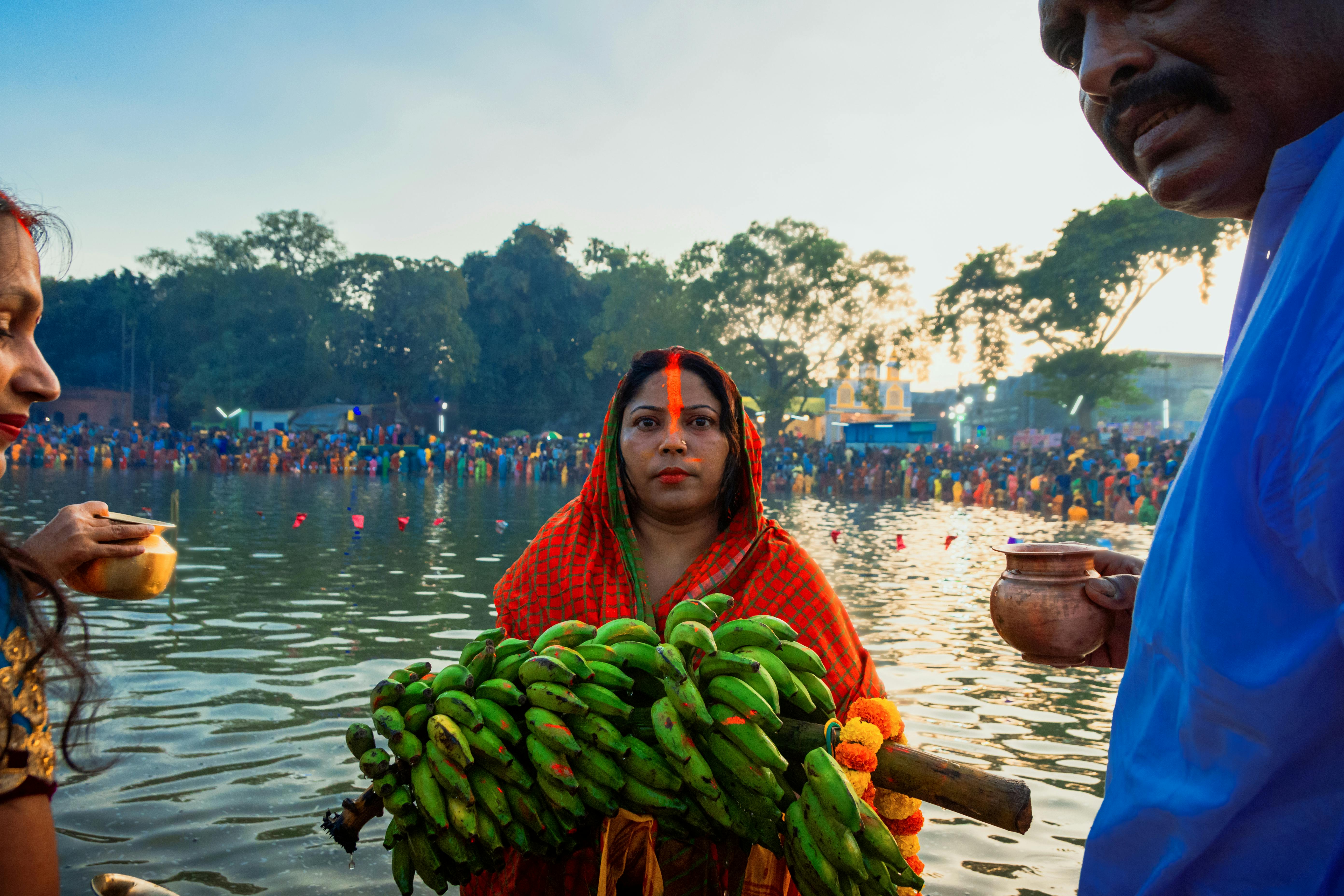 Woman with Bananas by River during Festival · Free Stock Photo