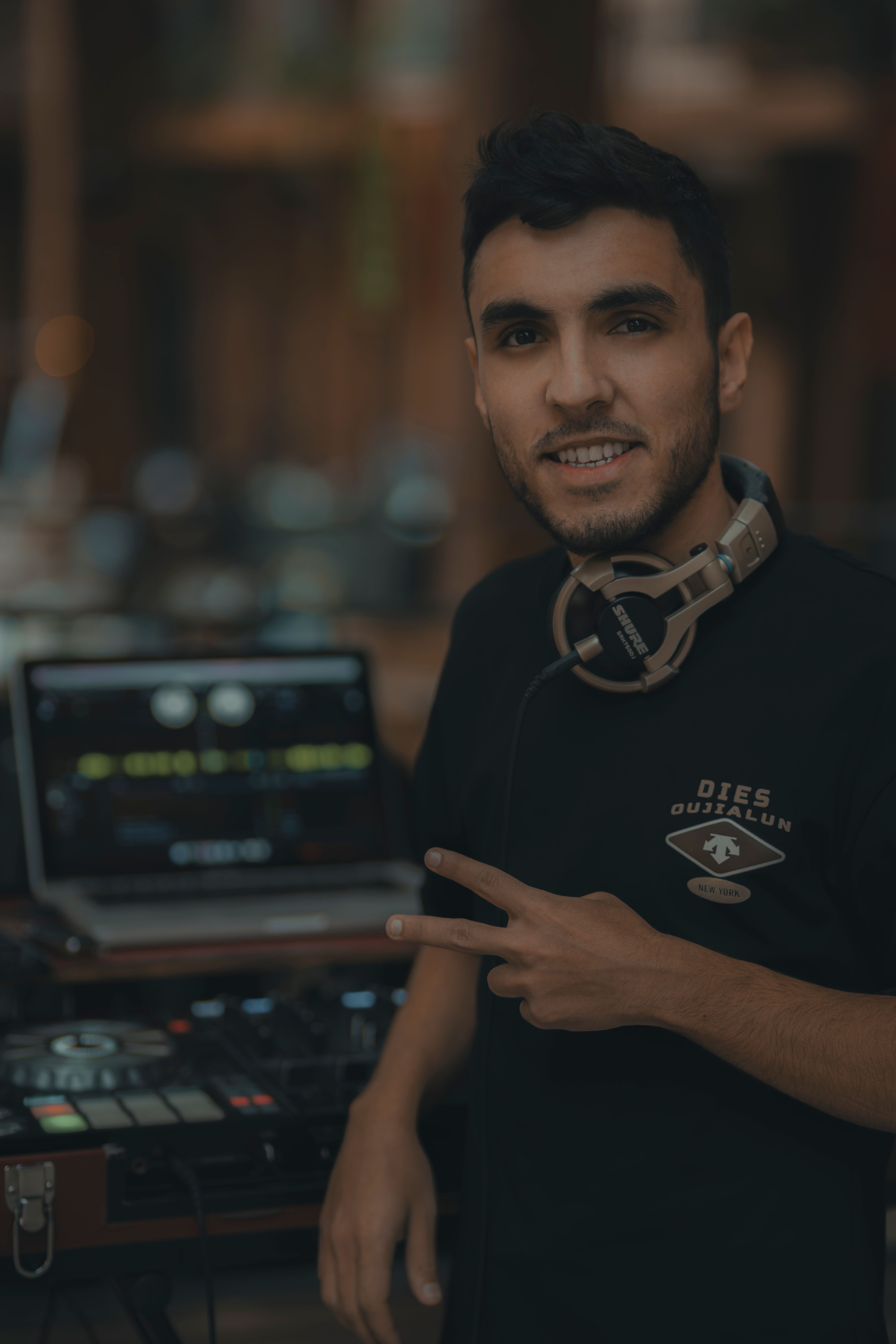 Young Man Posing in front of an Audio Mixer · Free Stock Photo