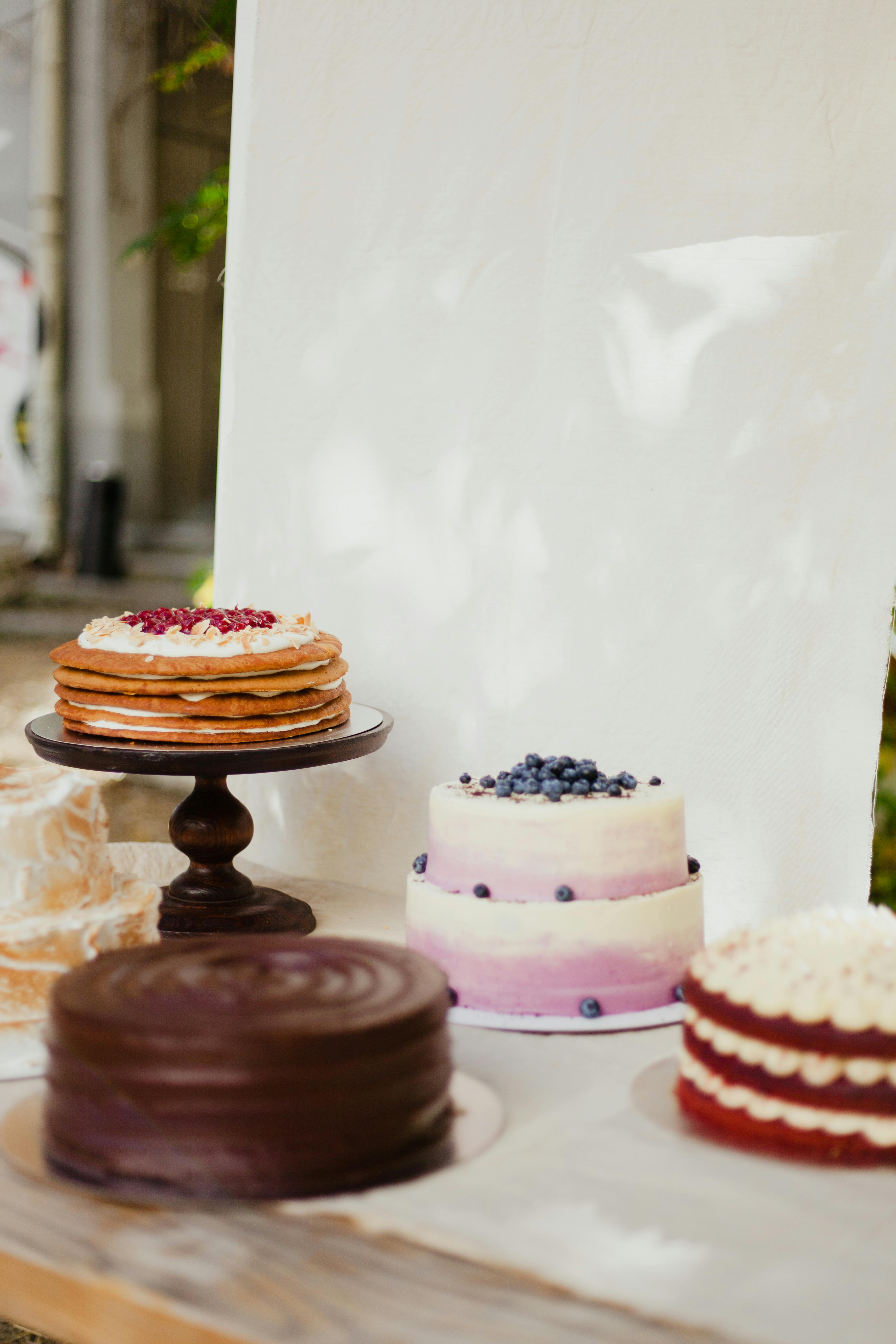 Black Round Cake With Gold Details On Brown Wooden Table · Free Stock Photo