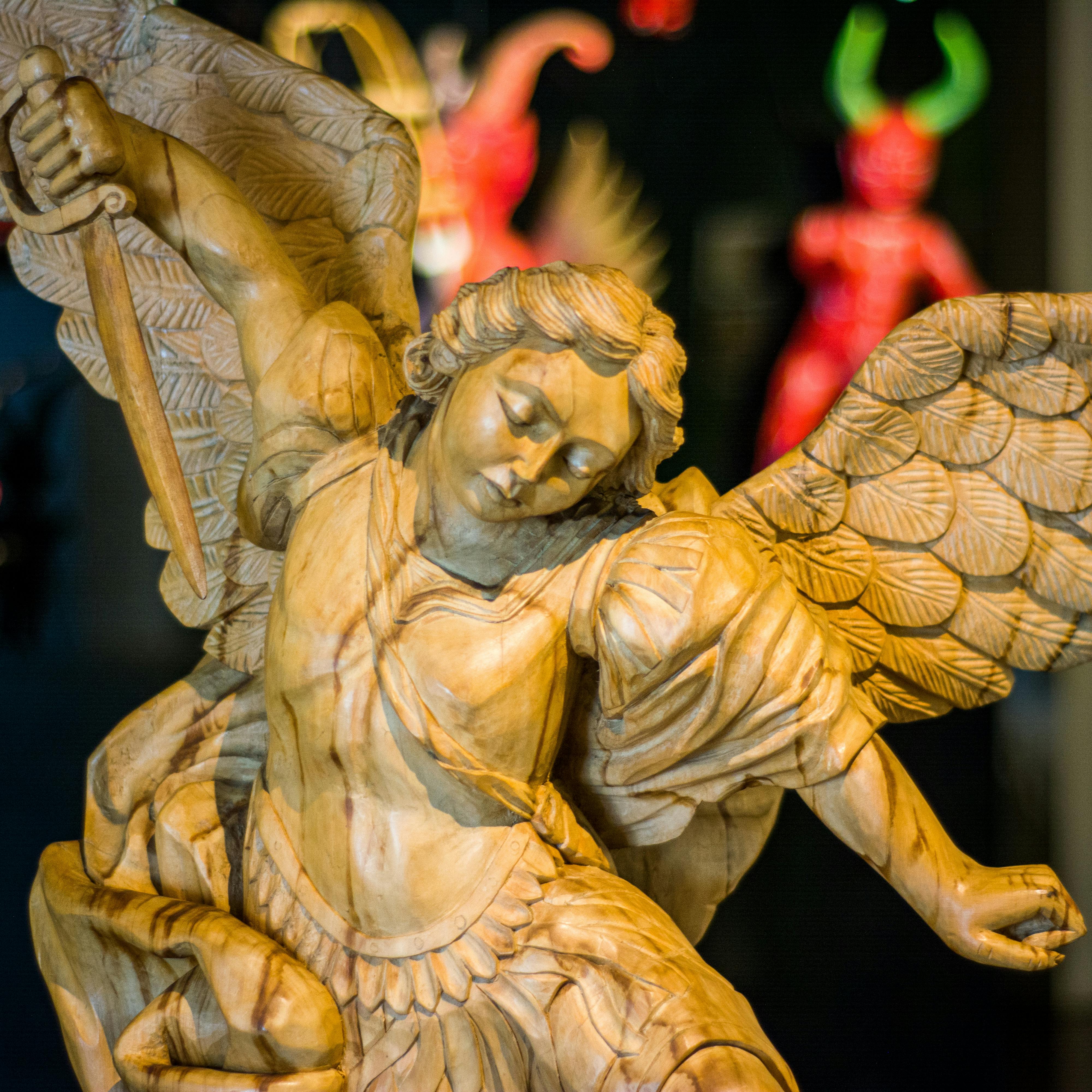 Close-up of a Statue of an Angel Holding a Sword · Free Stock Photo