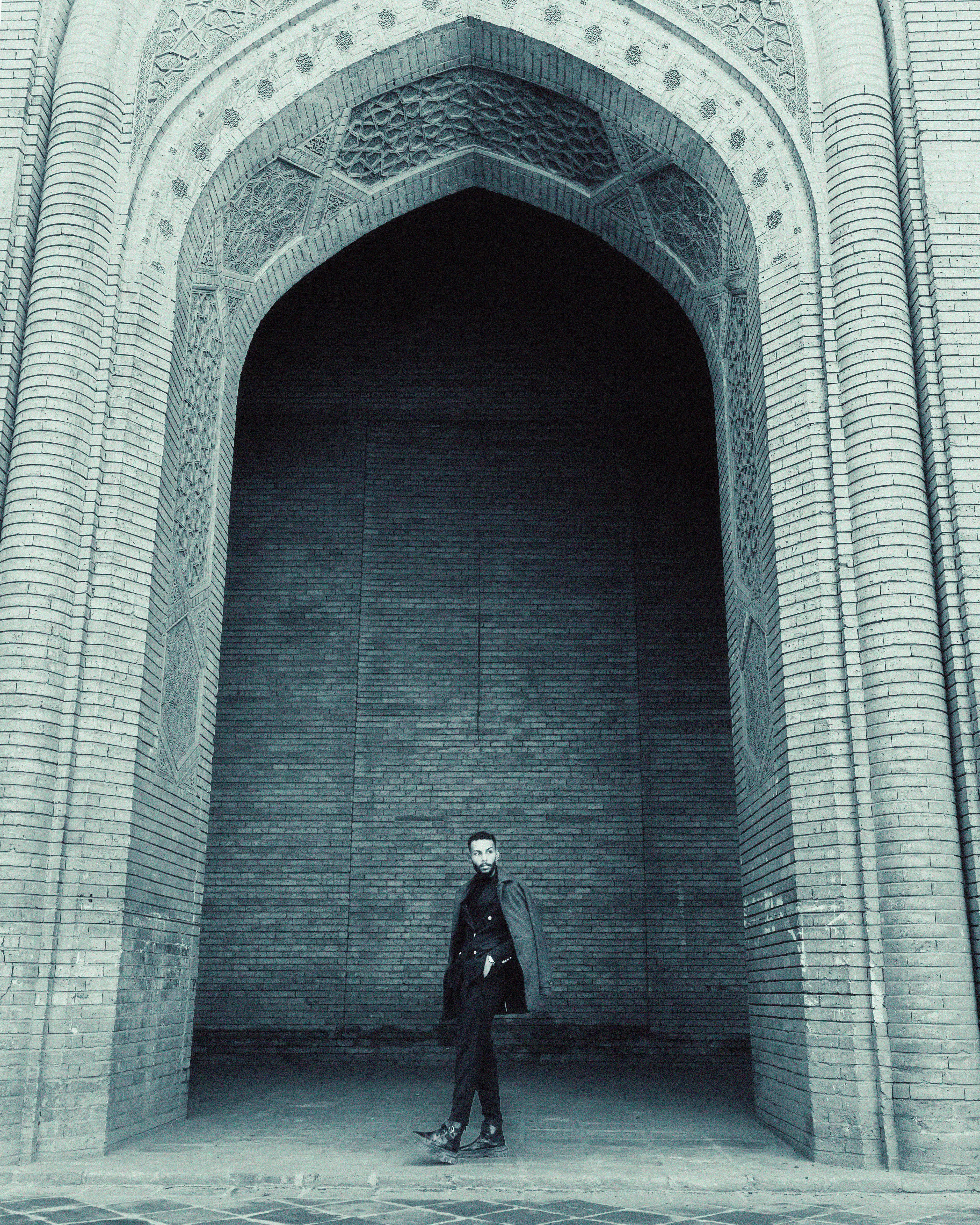 Man Posing under an Arch · Free Stock Photo