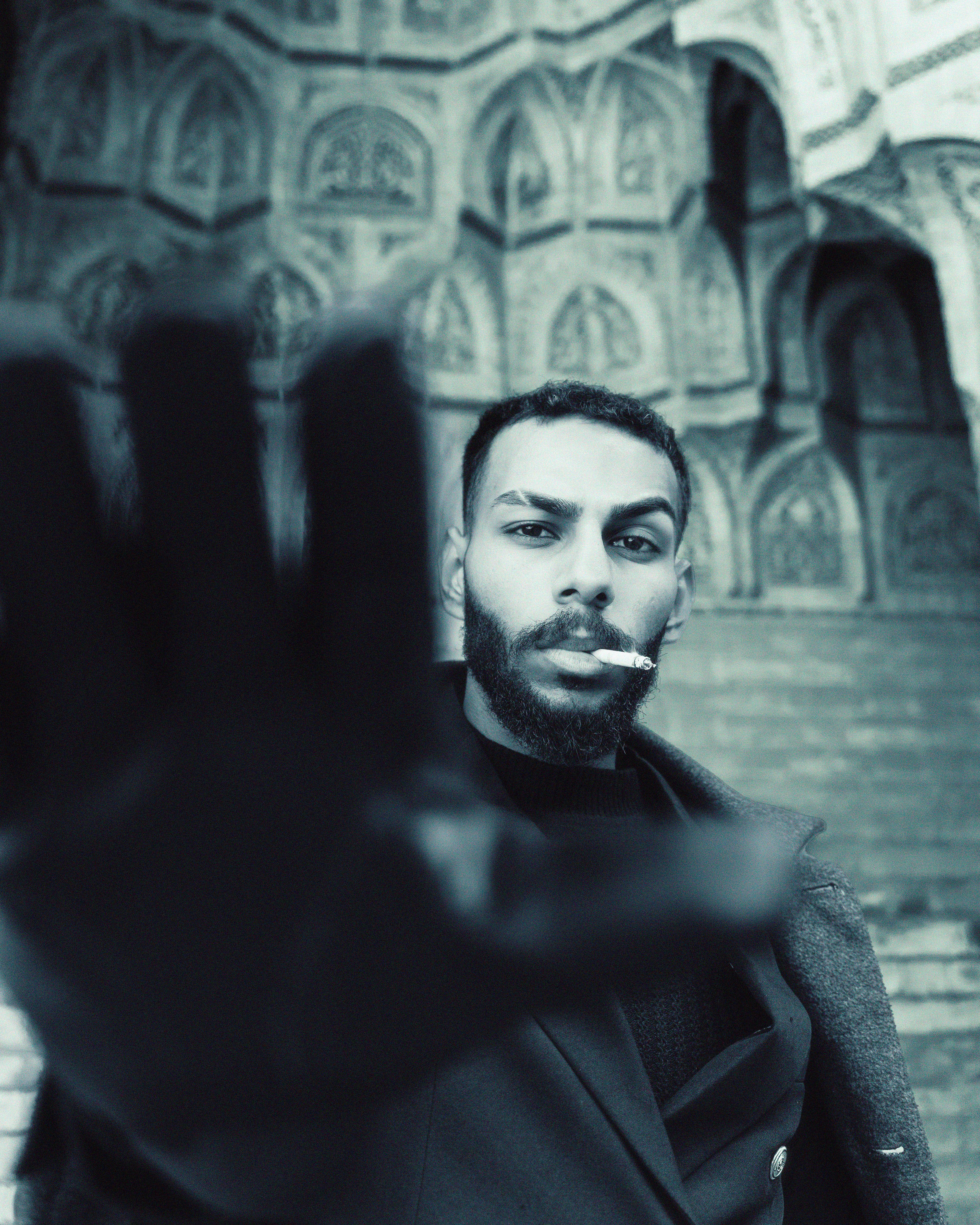 Man Smoking a Cigarette with His Gloved Hand Stretched Out in Front of ...