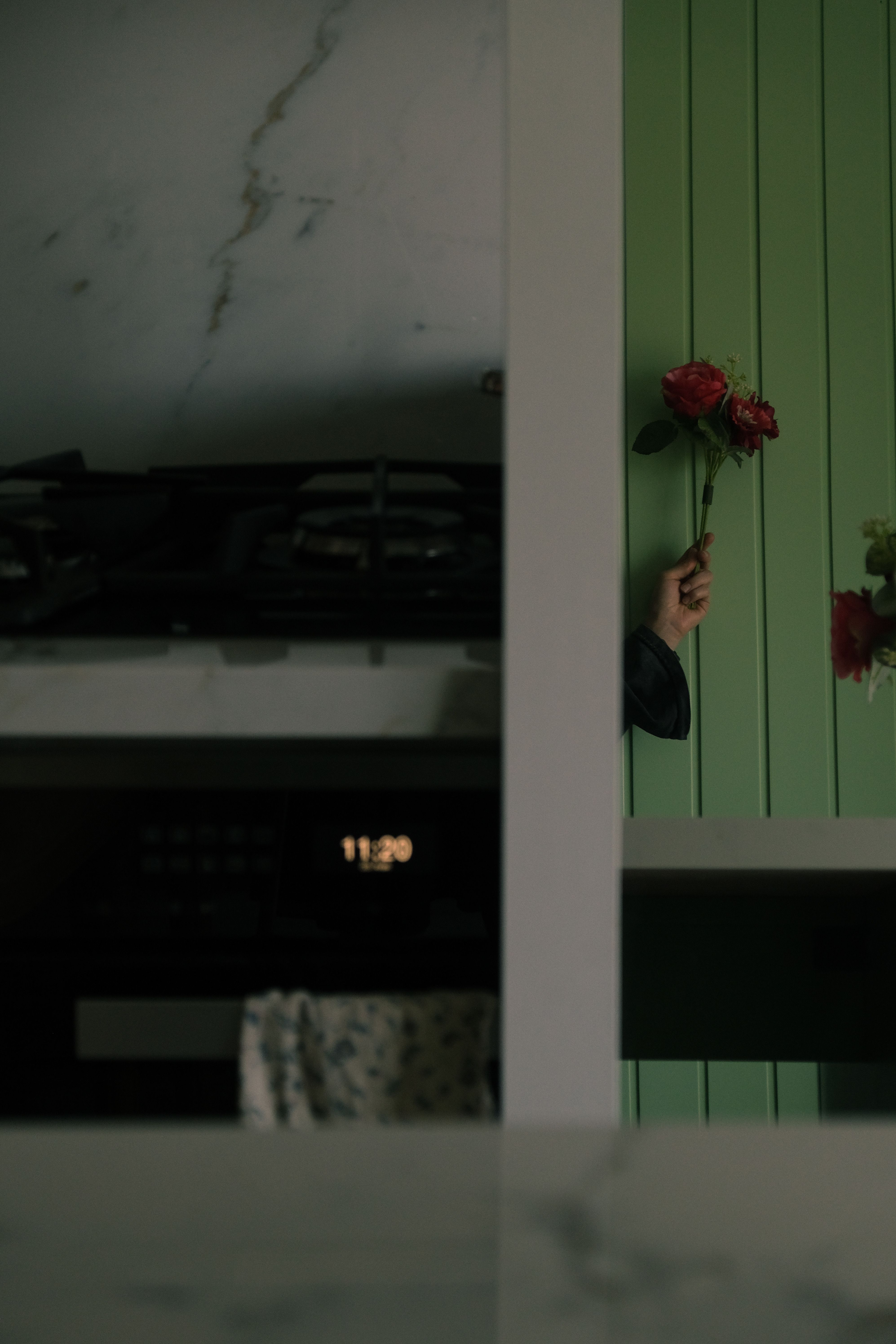 Reflection of a Hand Holding Flowers in a Mirror in the Kitchen · Free ...