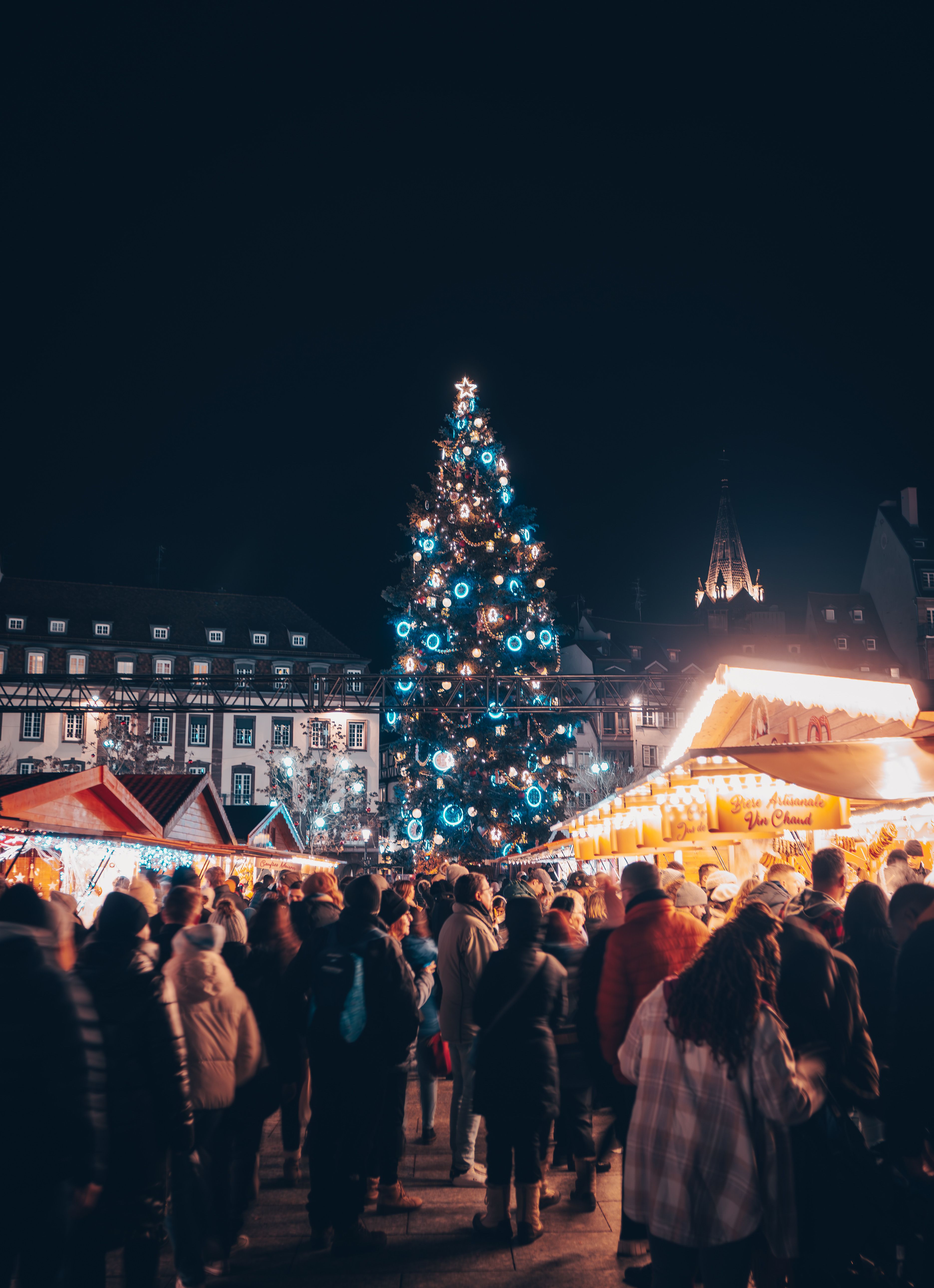 Crowds of People on a Christmas Market Square at Night · Free Stock Photo