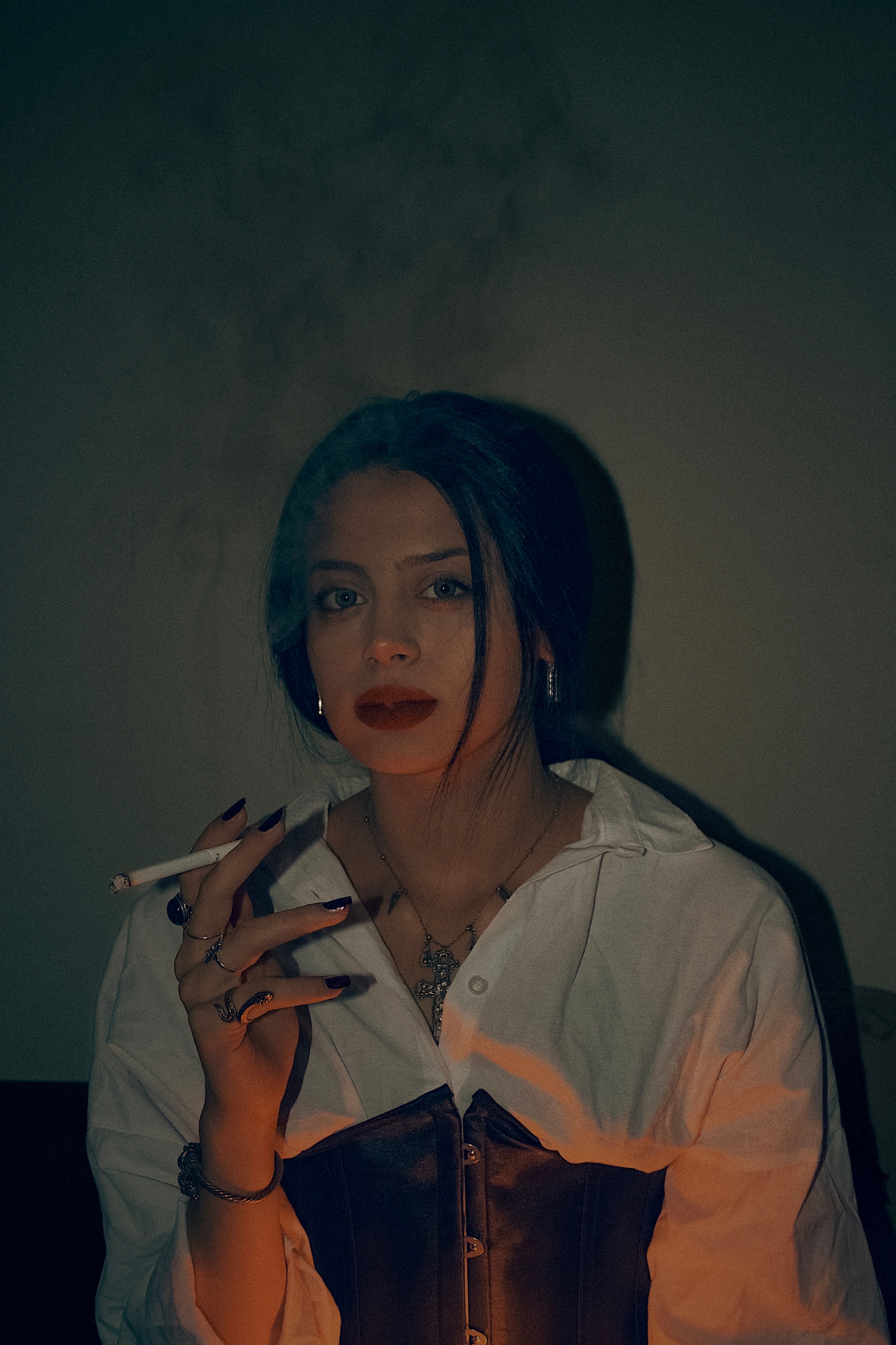 Portrait of a Pretty Brunette Smoking a Cigarette · Free Stock Photo