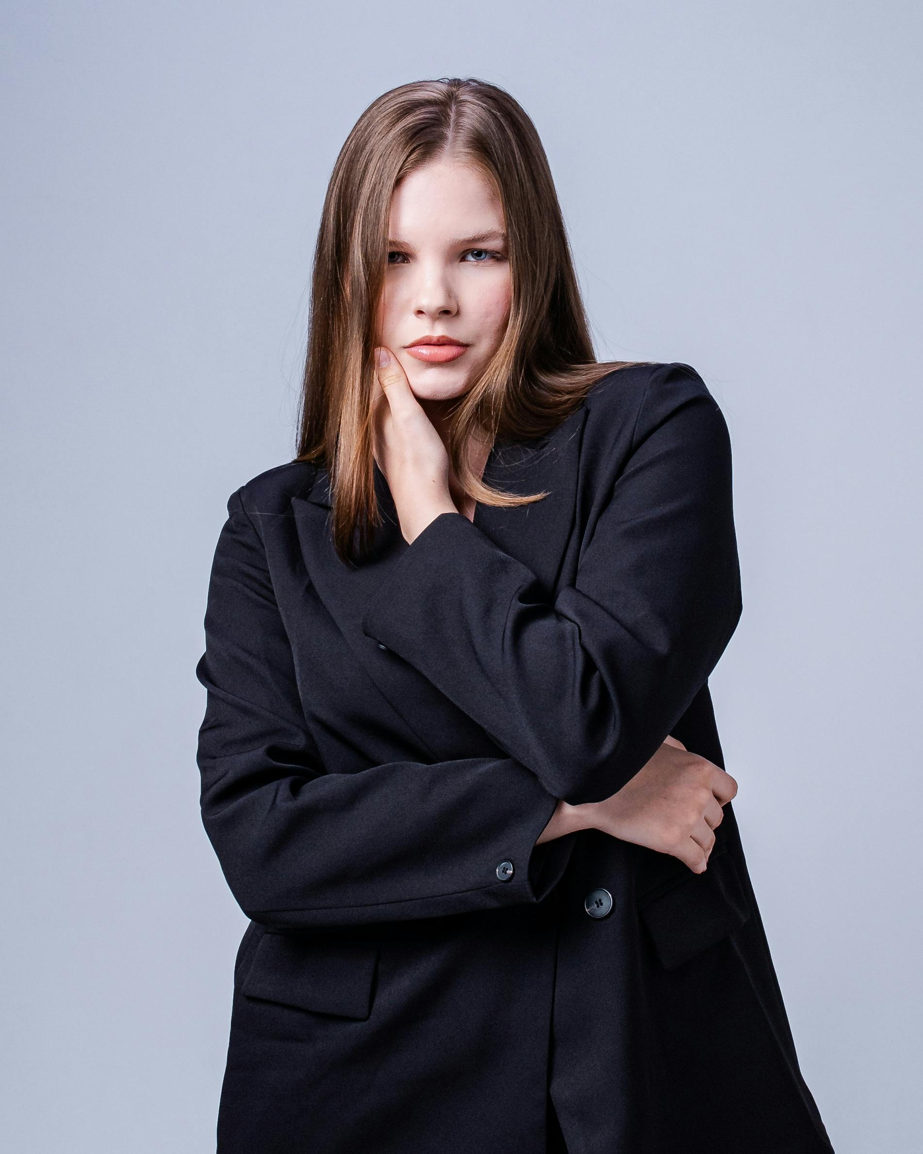 Woman in Black Blazer Posing against White Ba · Free Stock Photo