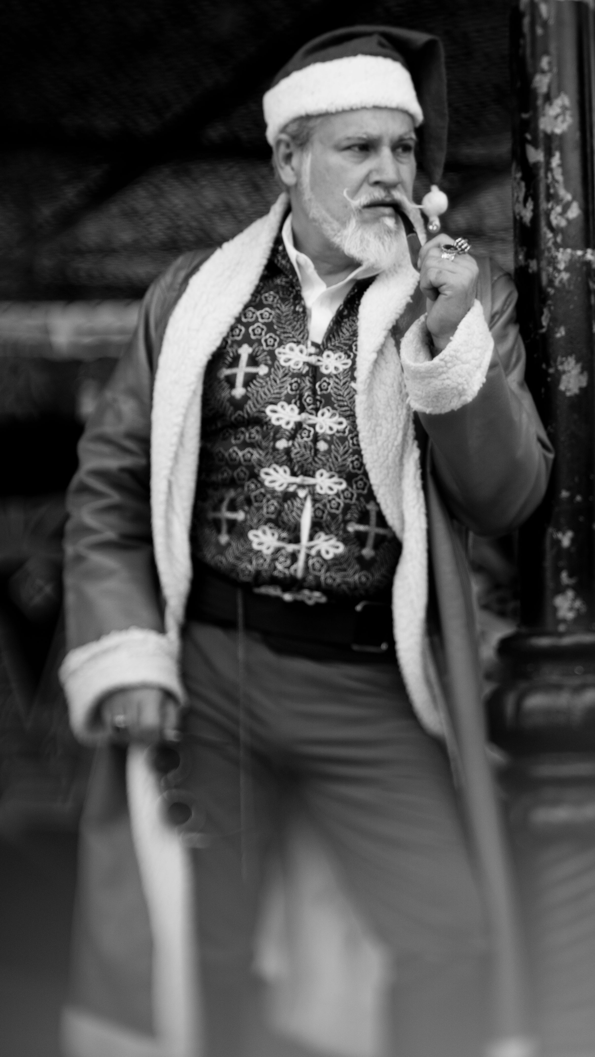 A man in a santa outfit smoking a cigarette · Free Stock Photo