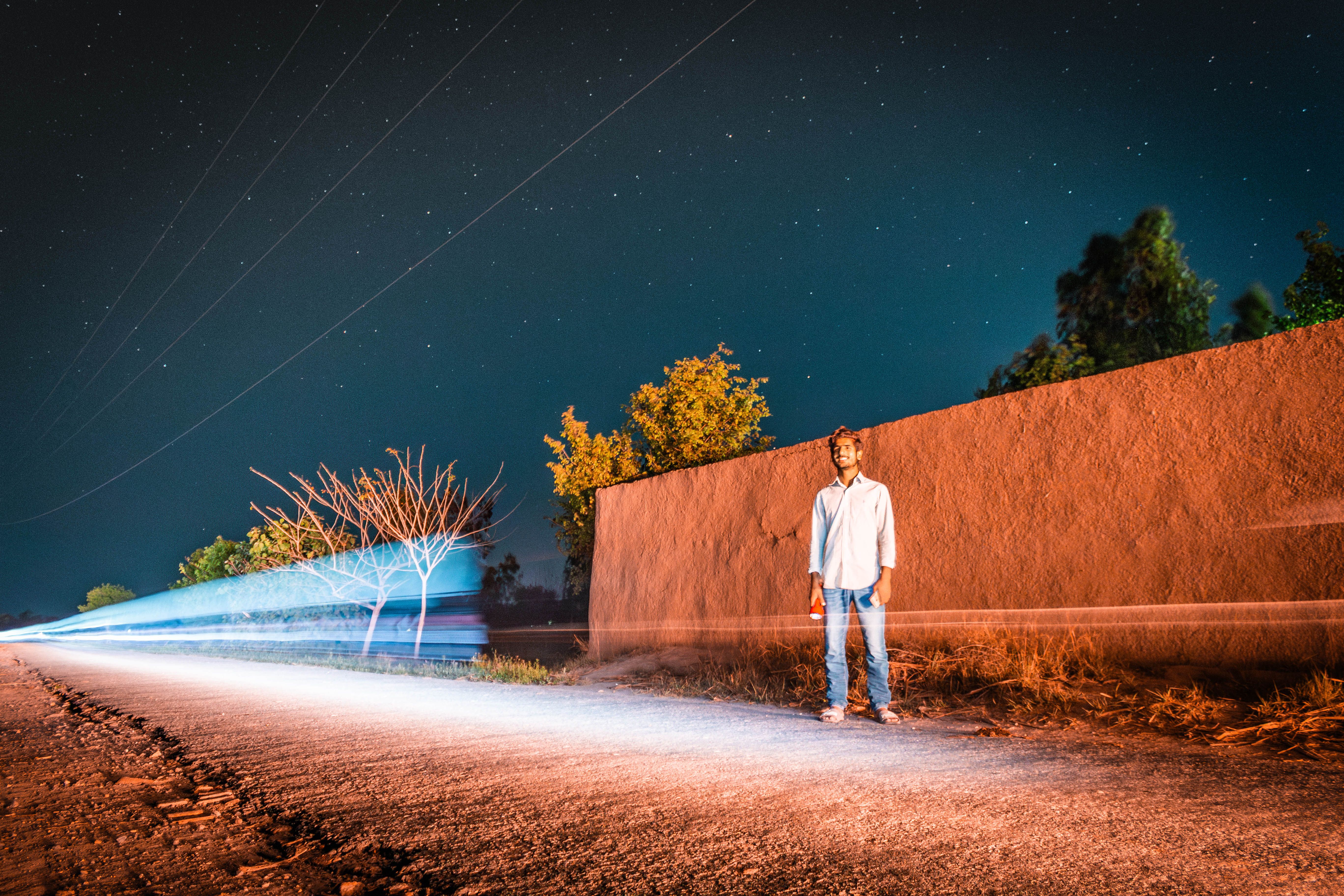 Man in Shirt Standing by Streaks of Light · Free Stock Photo