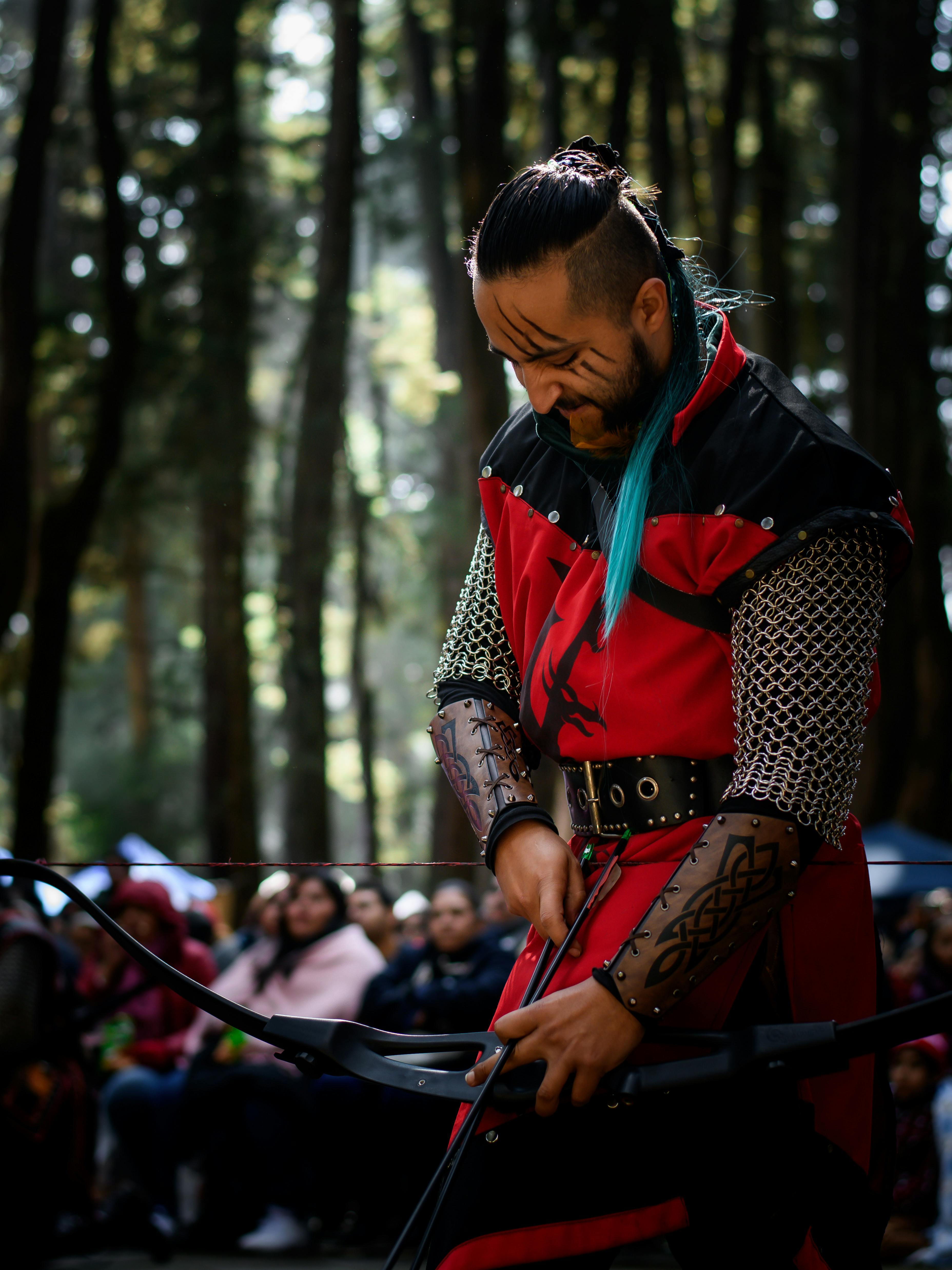 Archer in Medieval Costume and Chain Mail in Front of the Audience ...