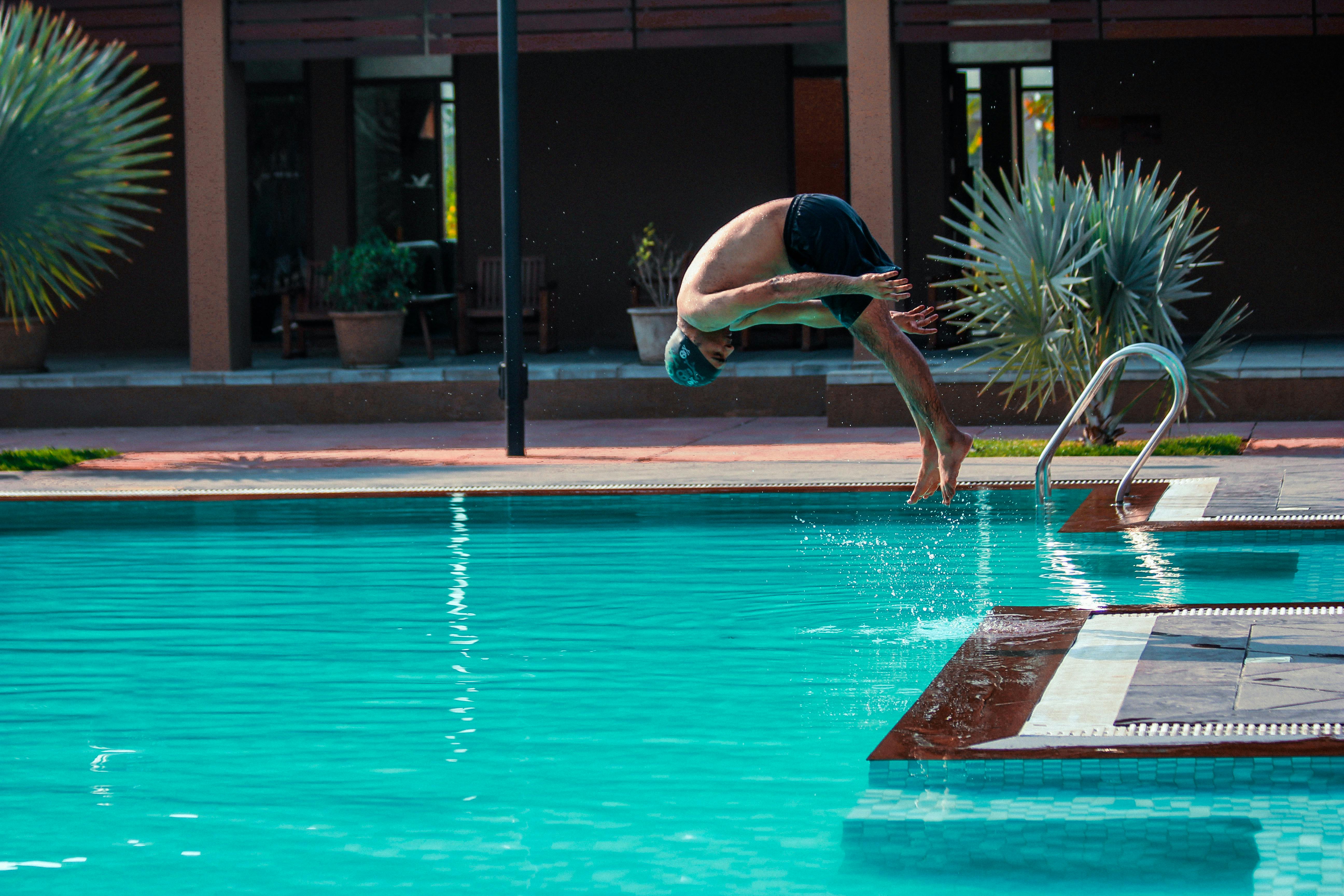 Photo Of Man Jumping In The Swimming Pool · Free Stock Photo