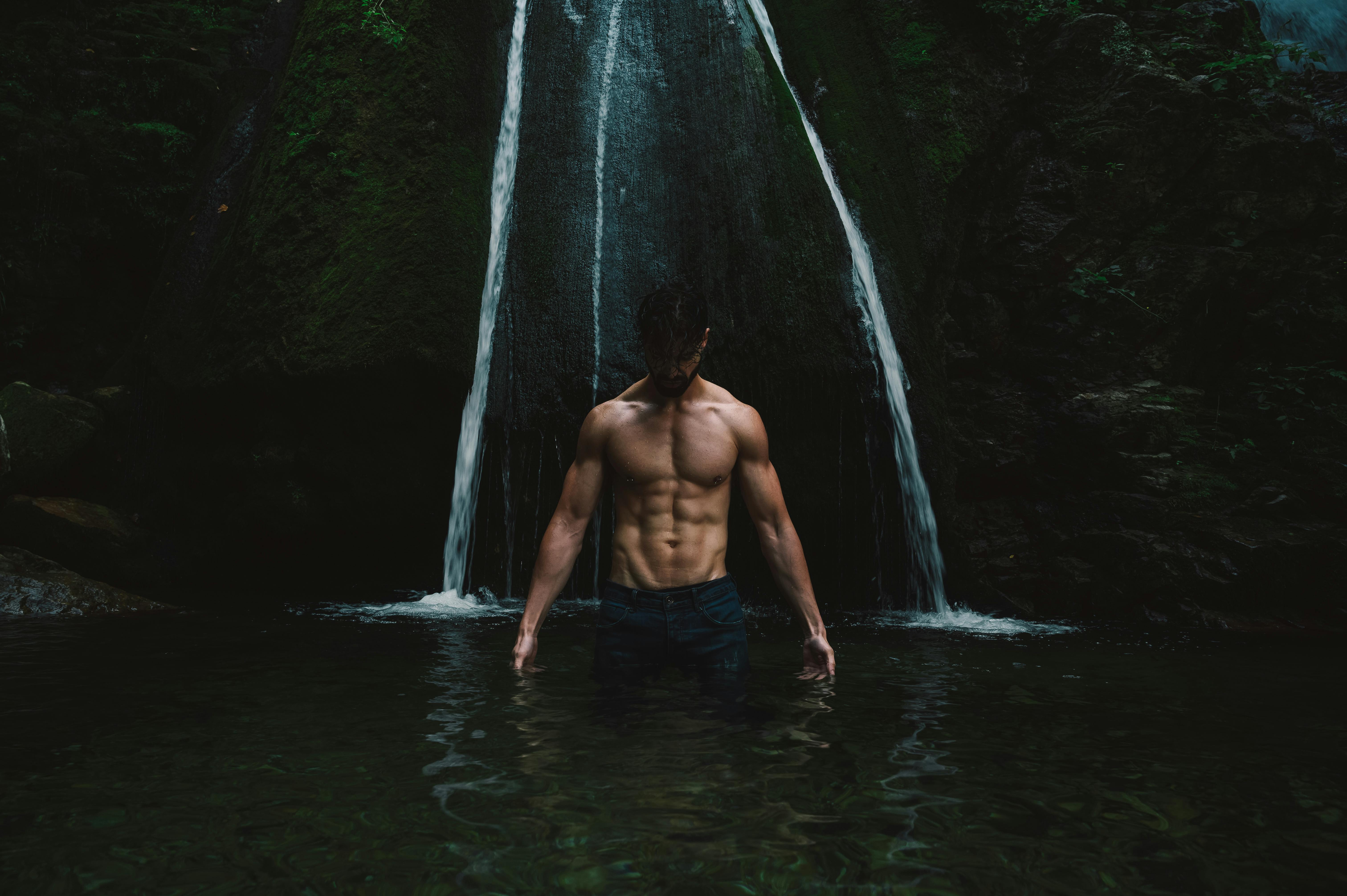 Man Standing under Waterfall · Free Stock Photo
