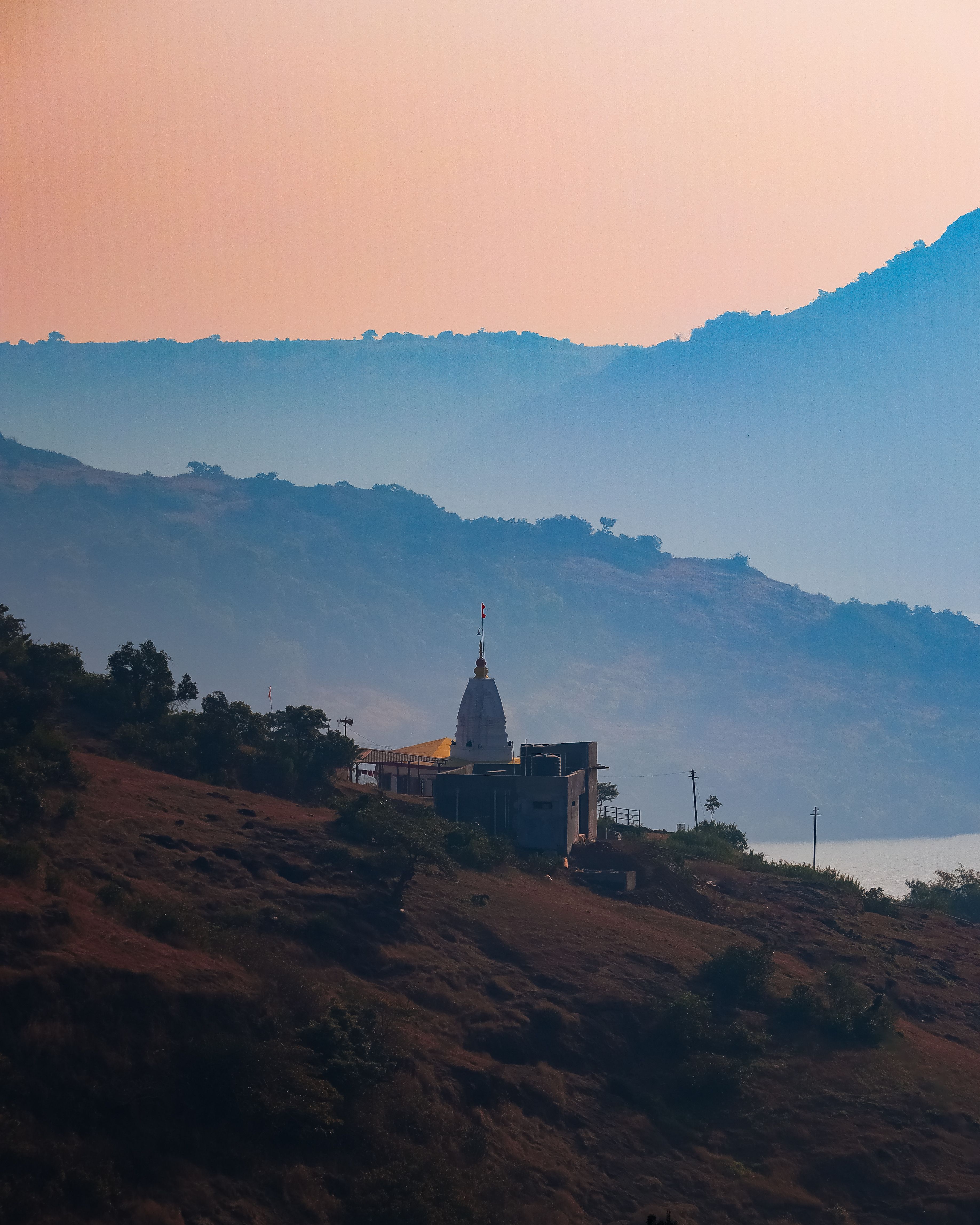 Building on Hills in Countryside at Sunset · Free Stock Photo