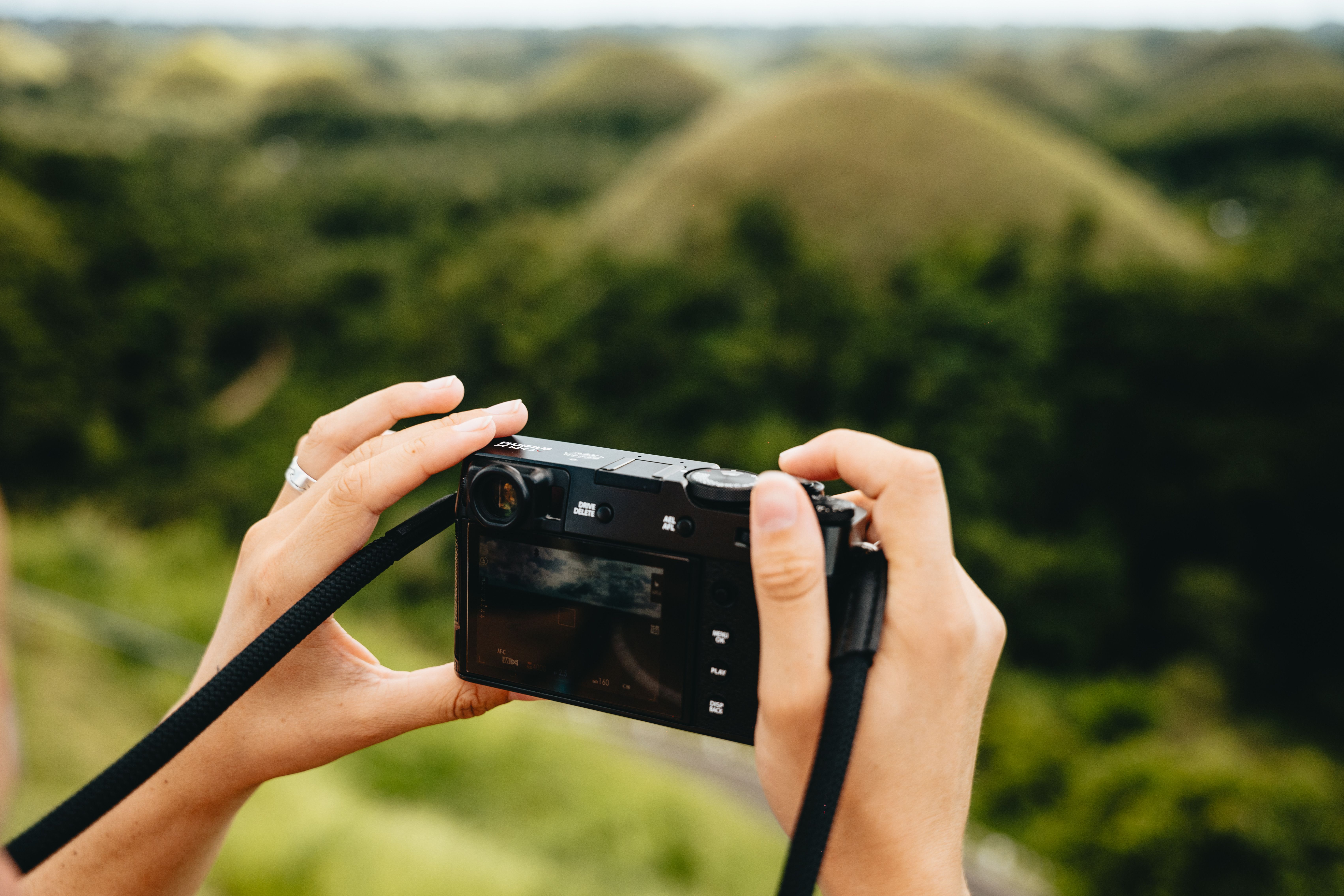 Woman Hands Holding Camera and Taking Pictures · Free Stock Photo