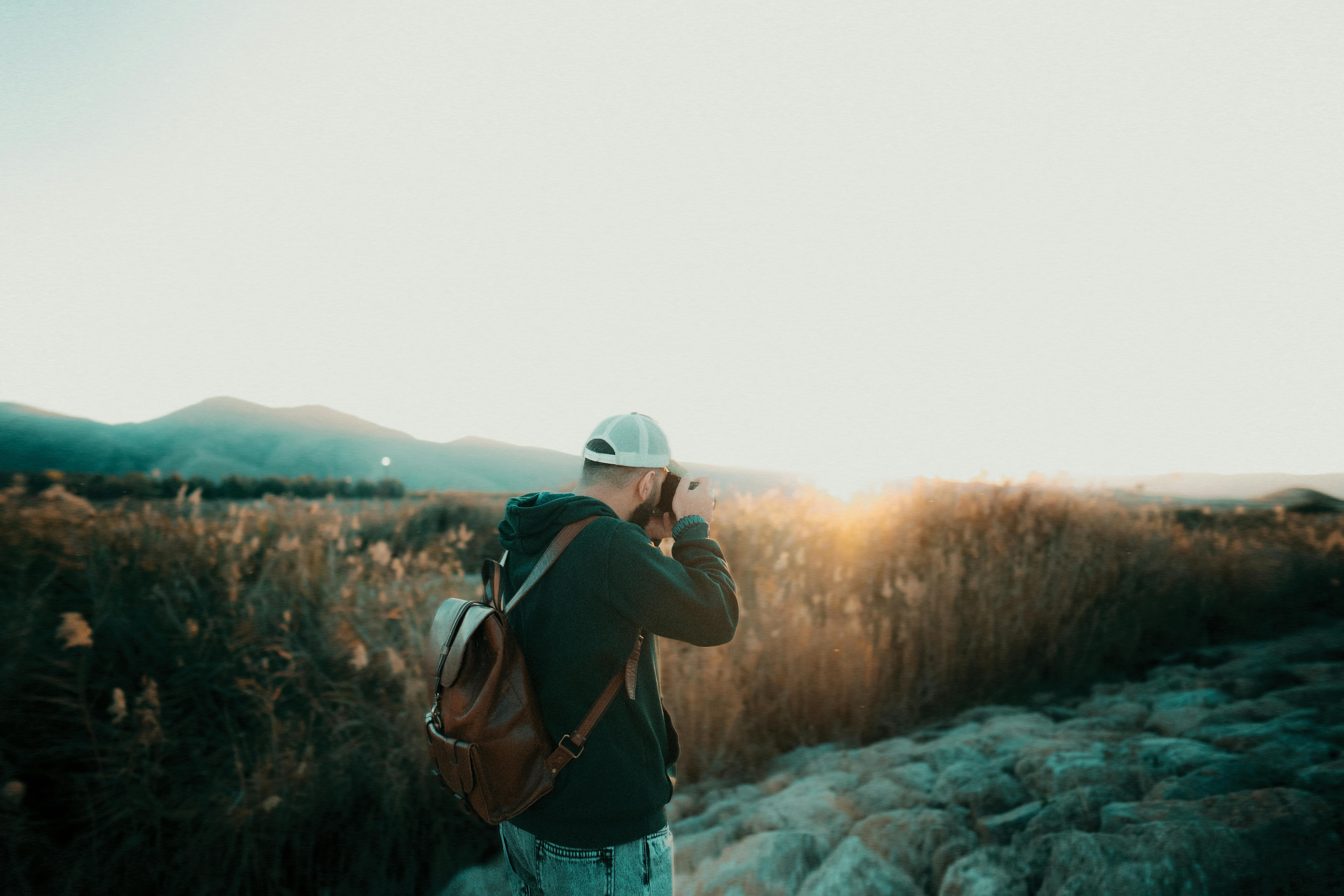 Man Standing on Rock During Sunset · Free Stock Photo