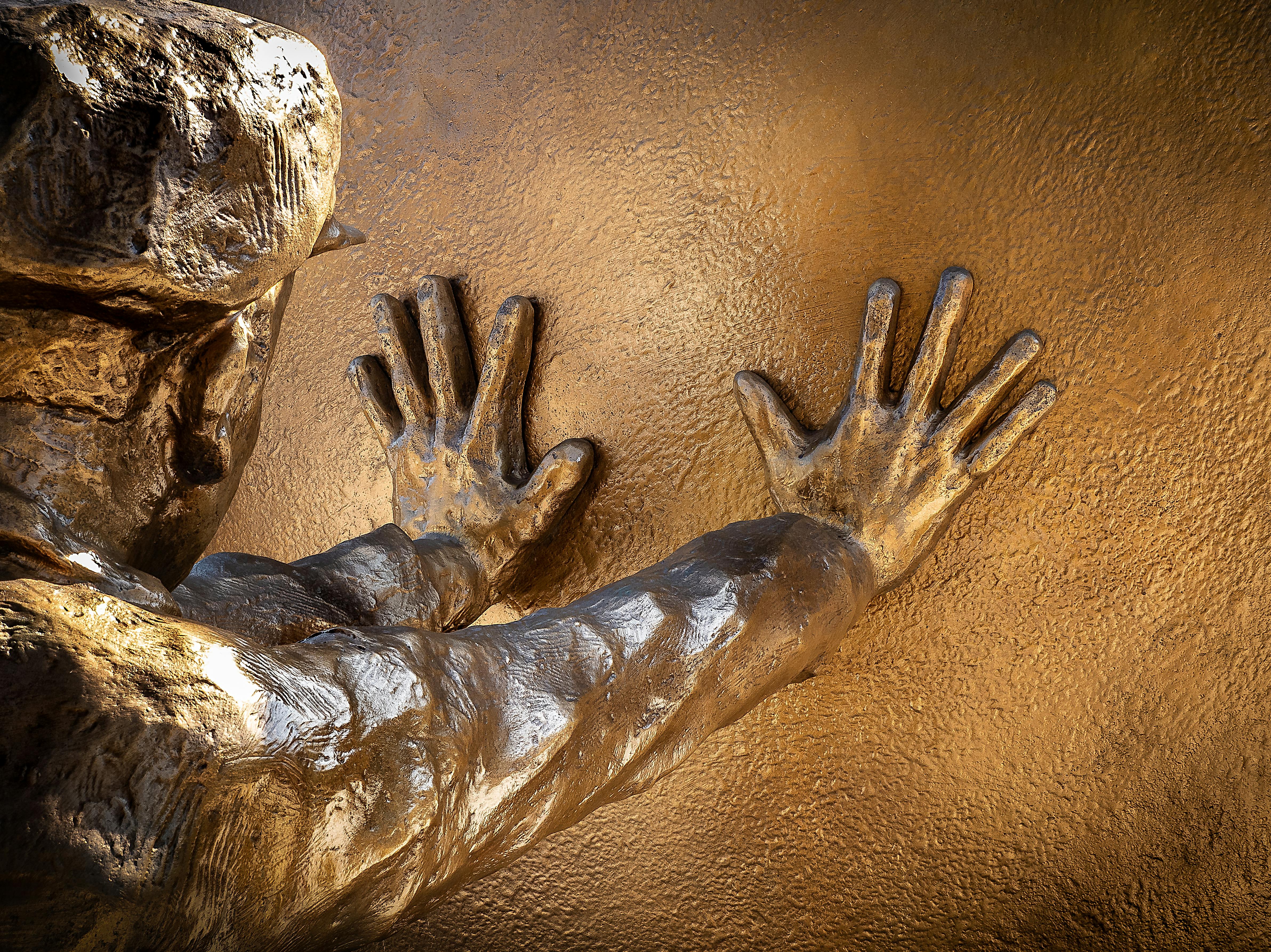 Statue of Man Touching Wall · Free Stock Photo