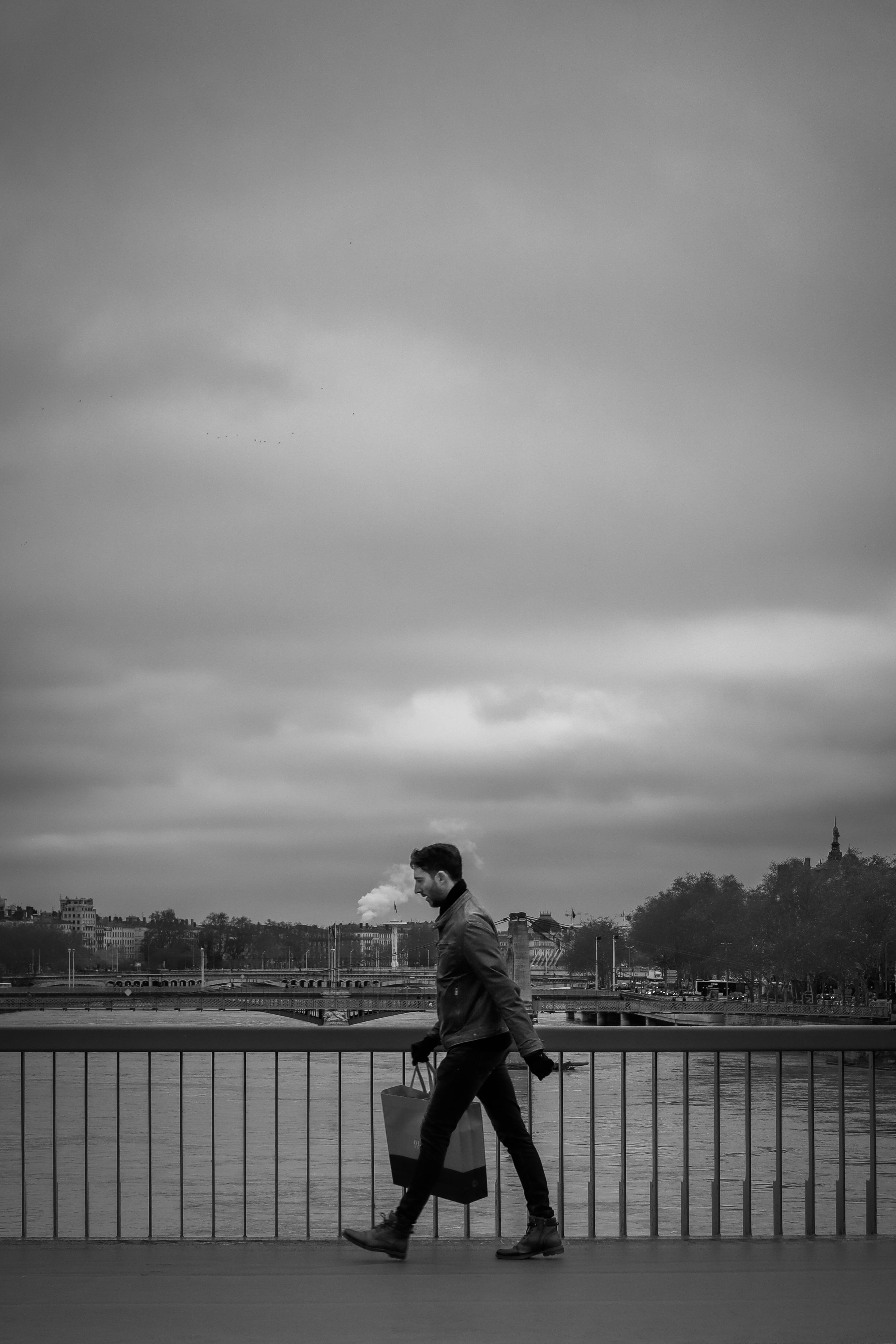 Man Walking on Bridge Across River · Free Stock Photo