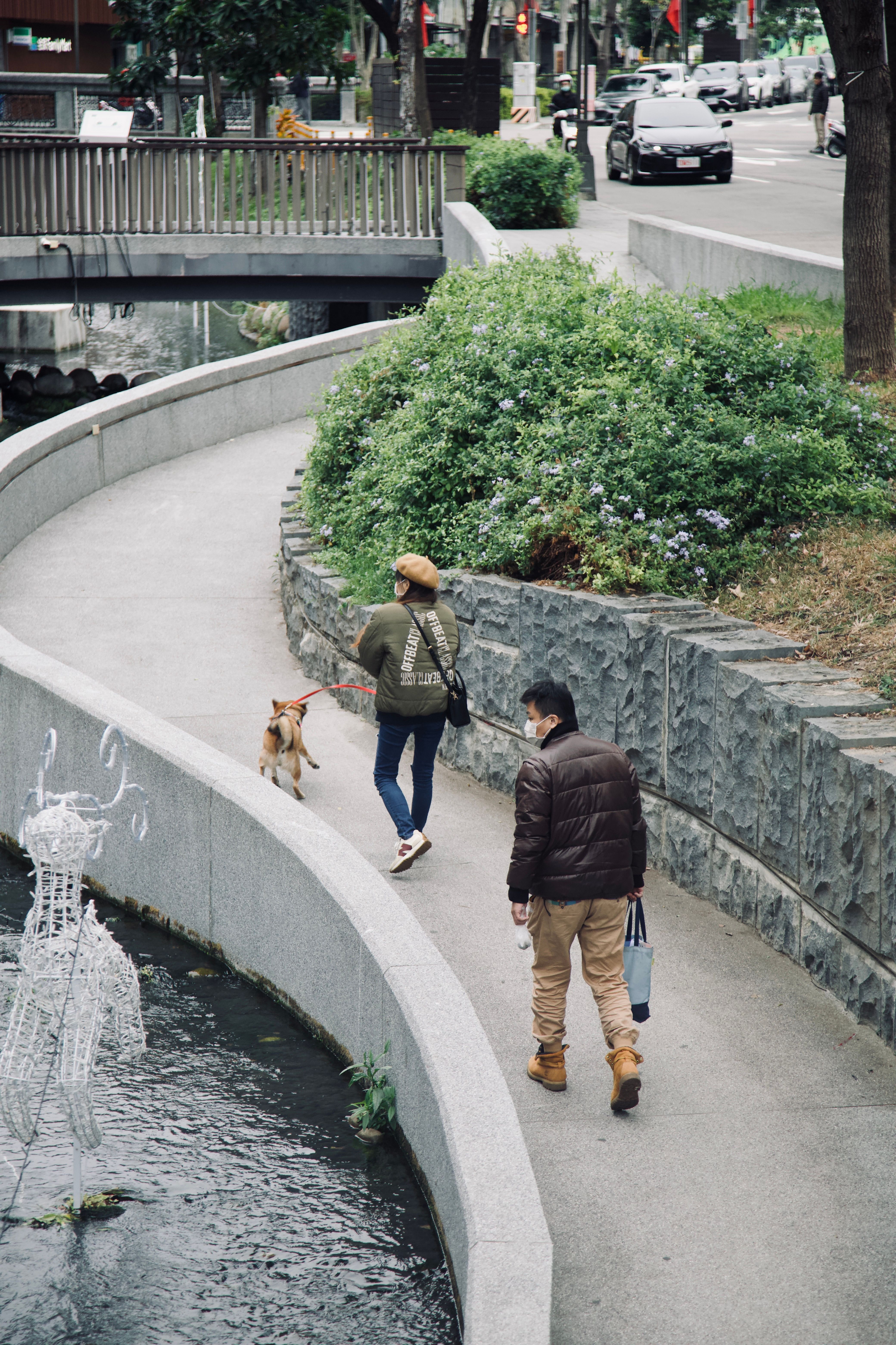 People Walking on a Path in a Modern Park · Free Stock Photo