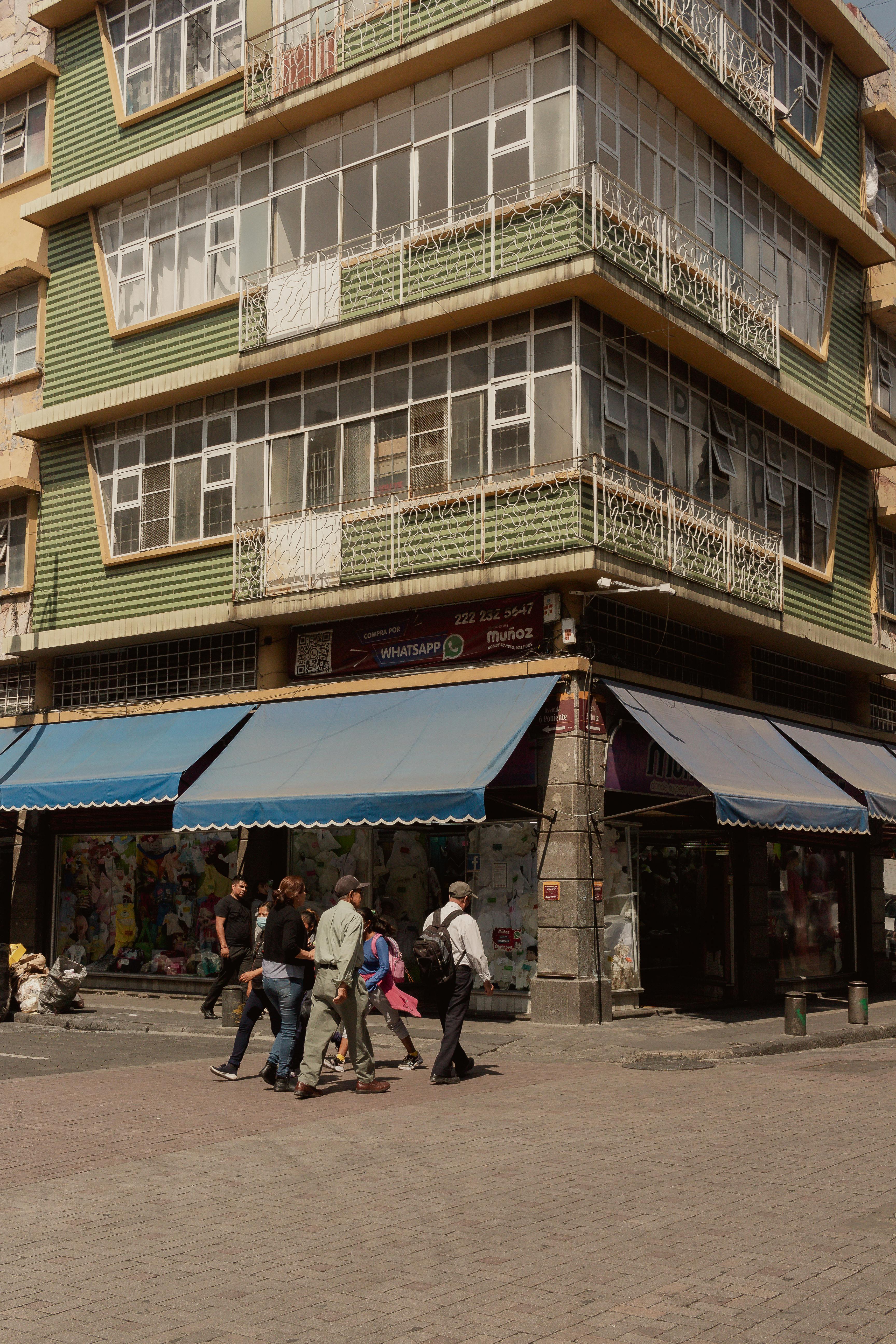 People Walking near Building Corner · Free Stock Photo