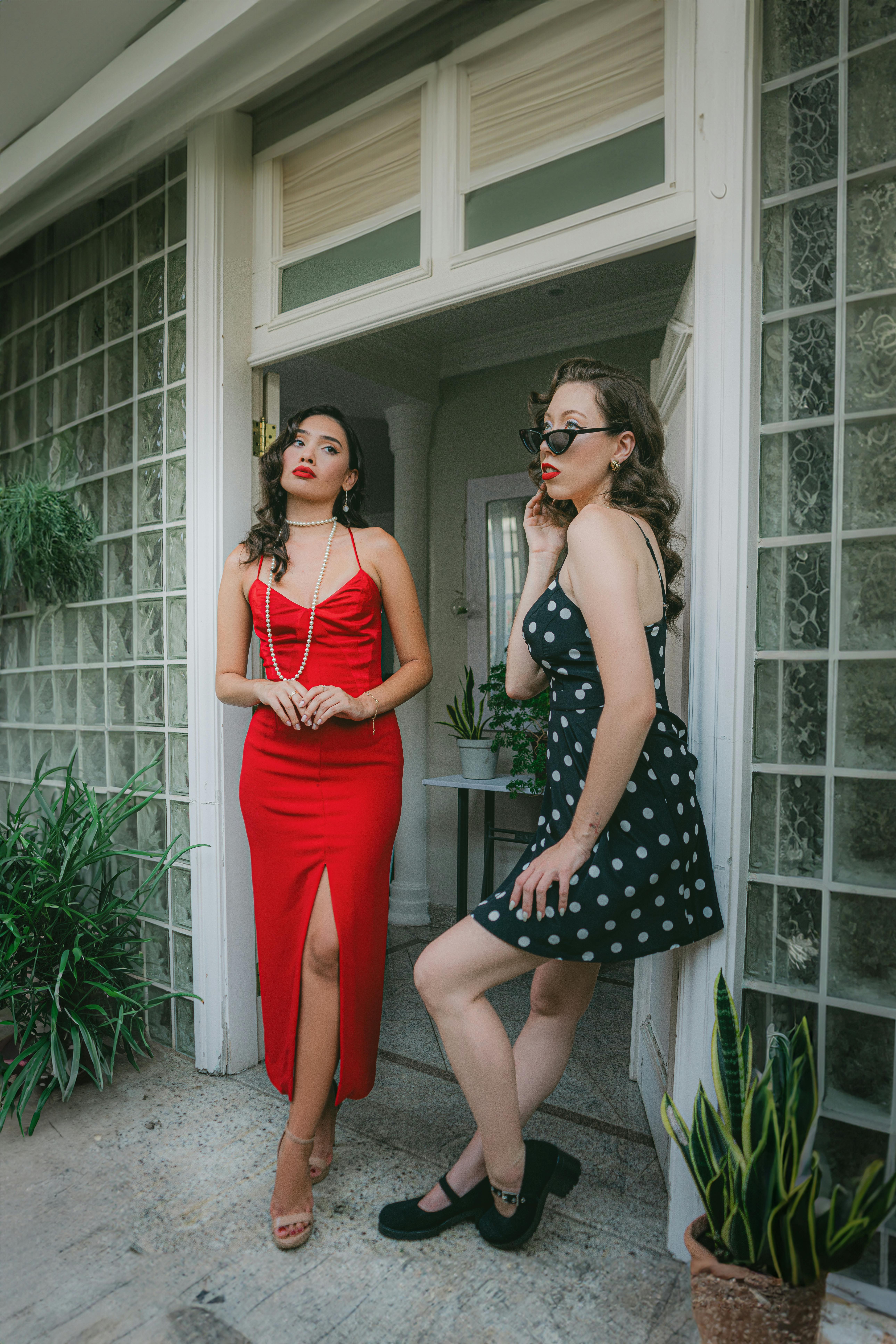 Two Female Models Standing in front of a Doorway · Free Stock Photo