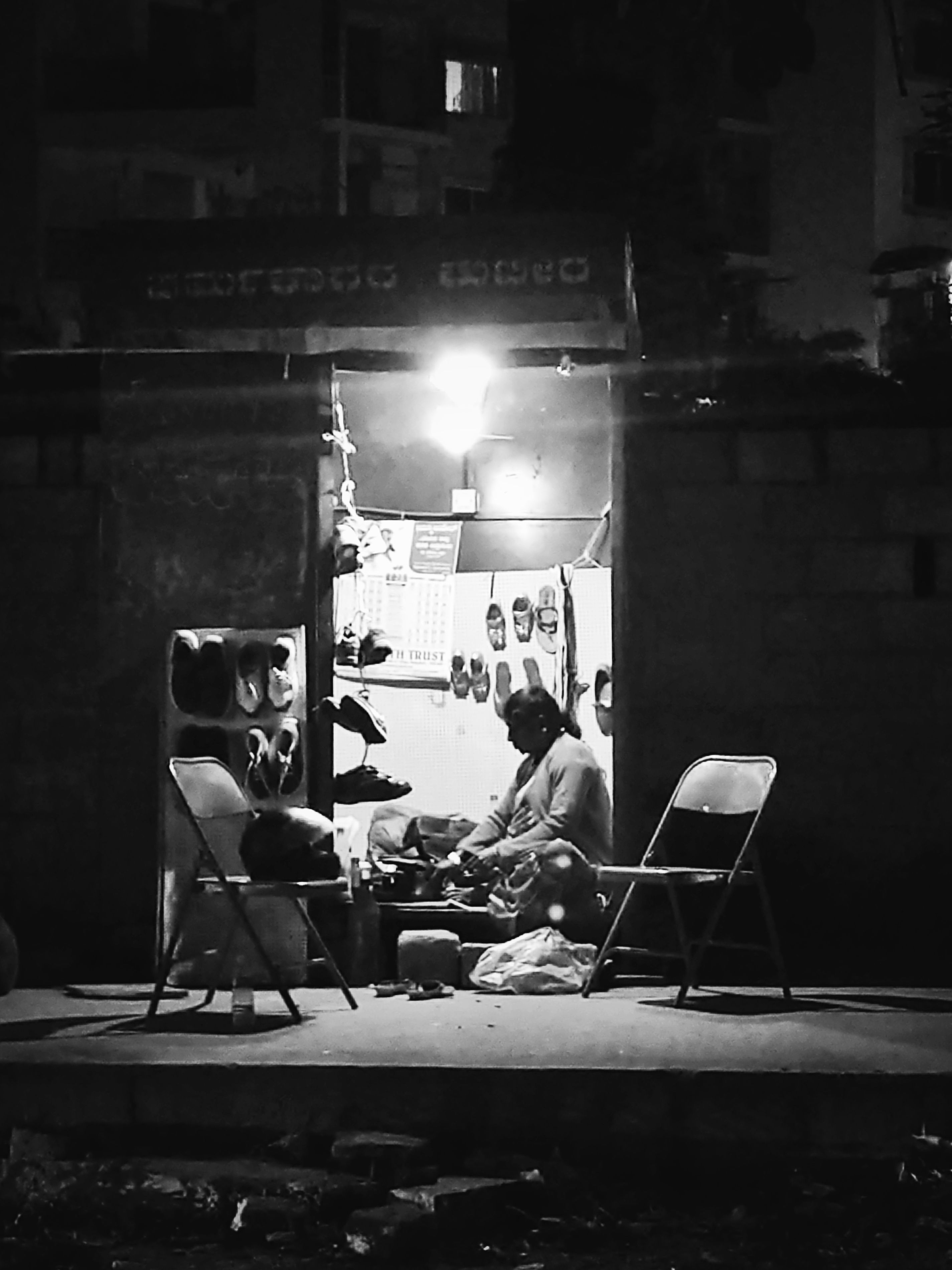 Woman Selling Shoes on a Street in Black and White · Free Stock Photo