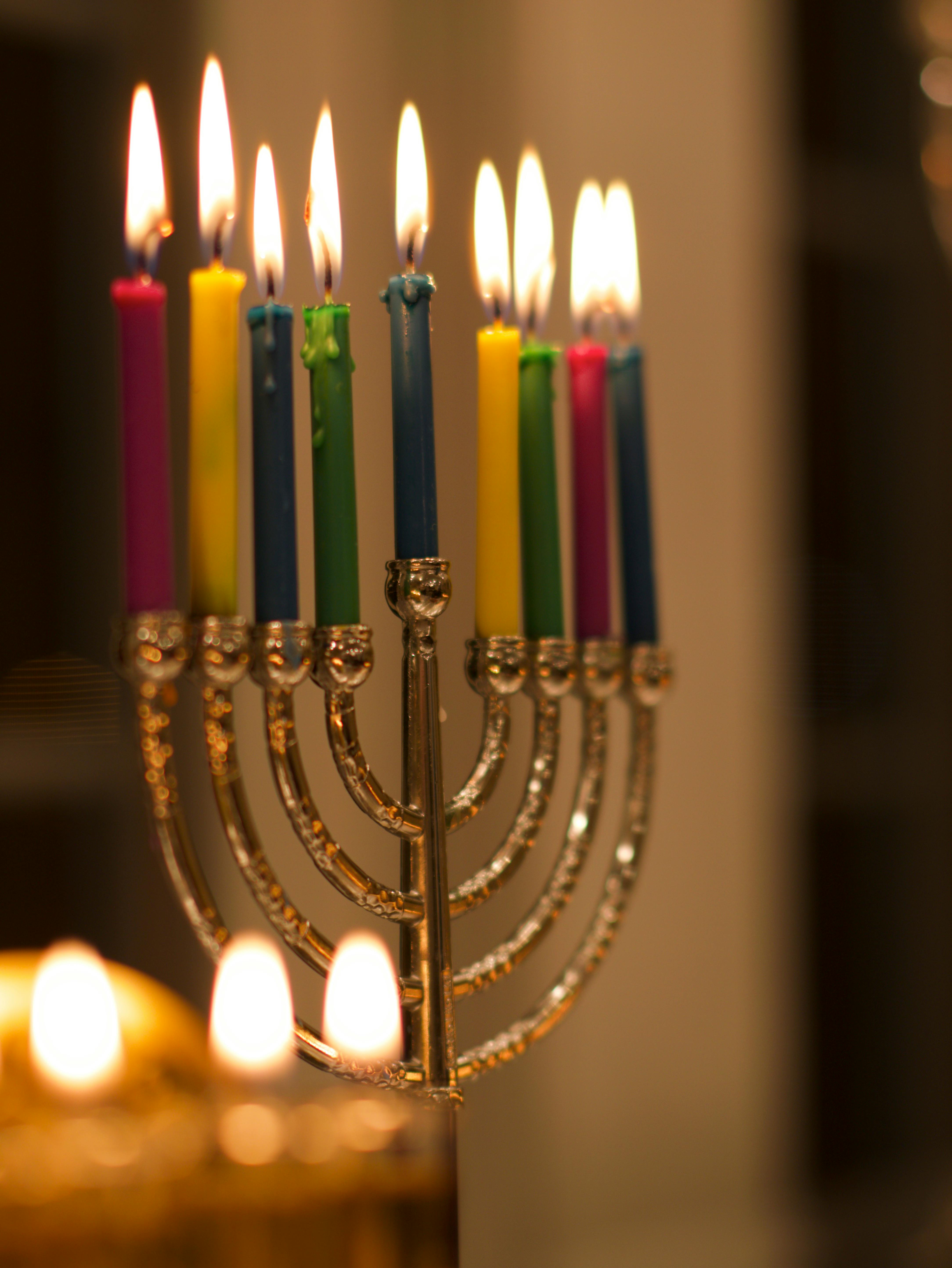 A menorah with many colored candles lit · Free Stock Photo