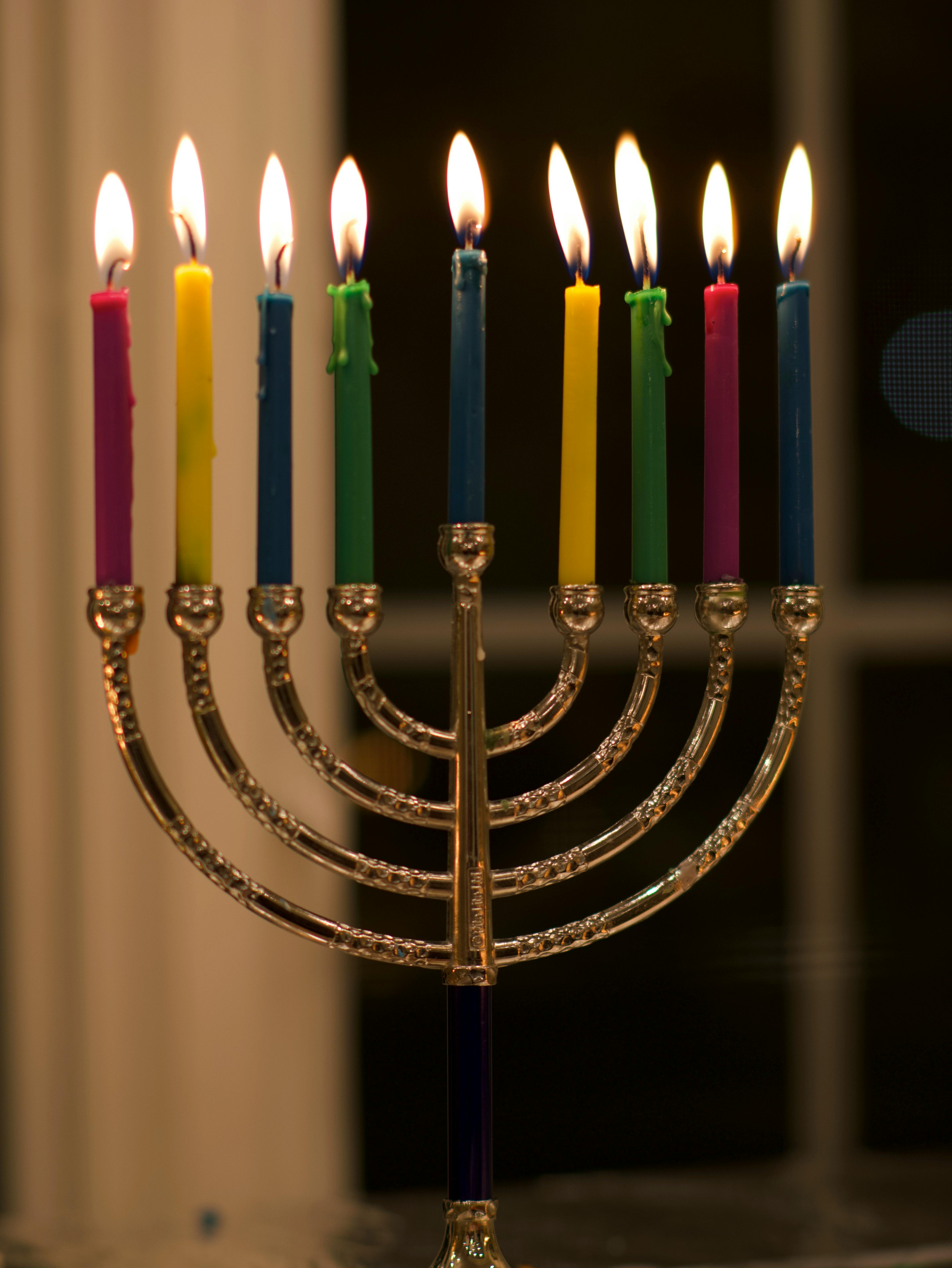A menorah with multi colored candles on it · Free Stock Photo