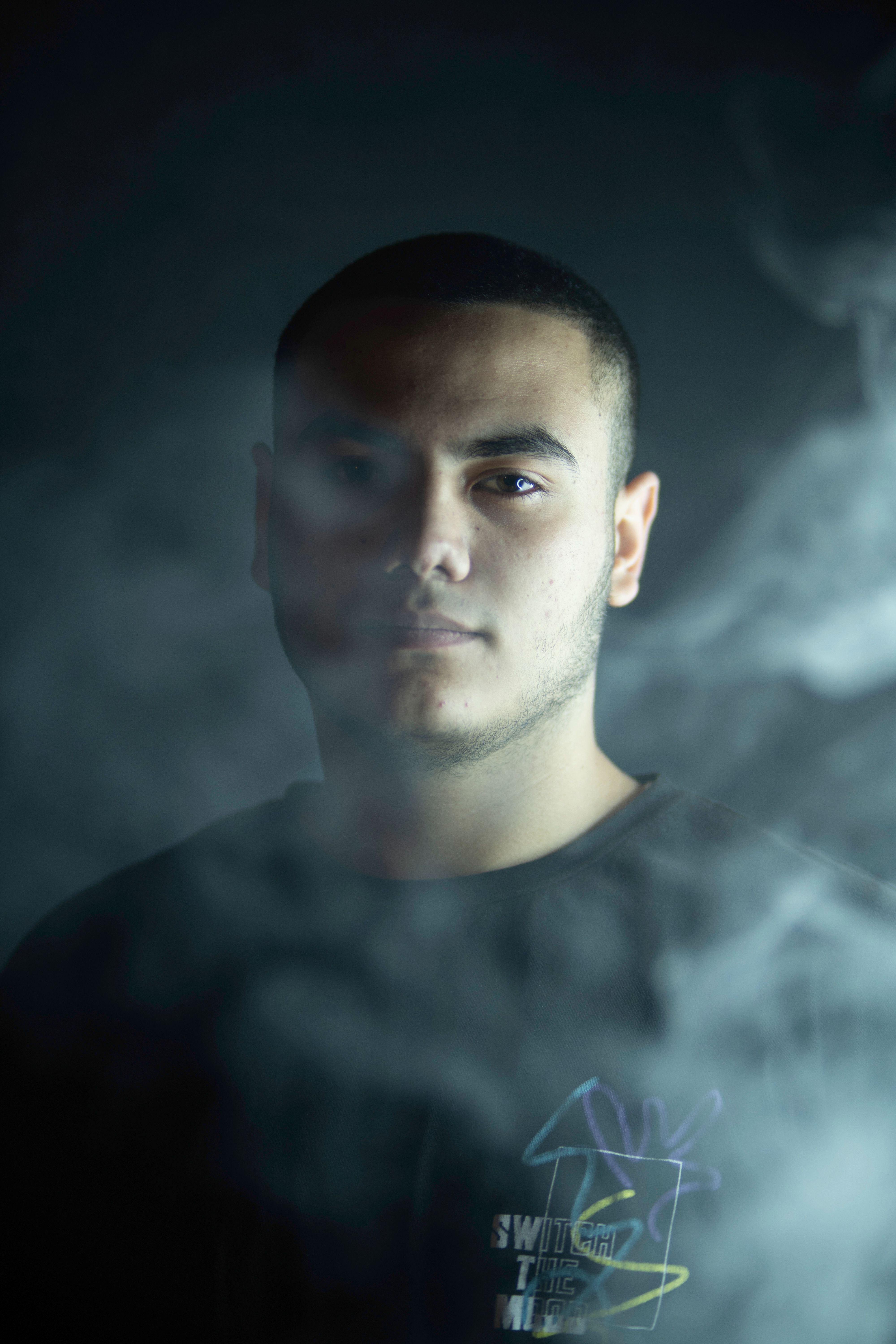 Studio Shot of a Young Man Standing in Smoke · Free Stock Photo