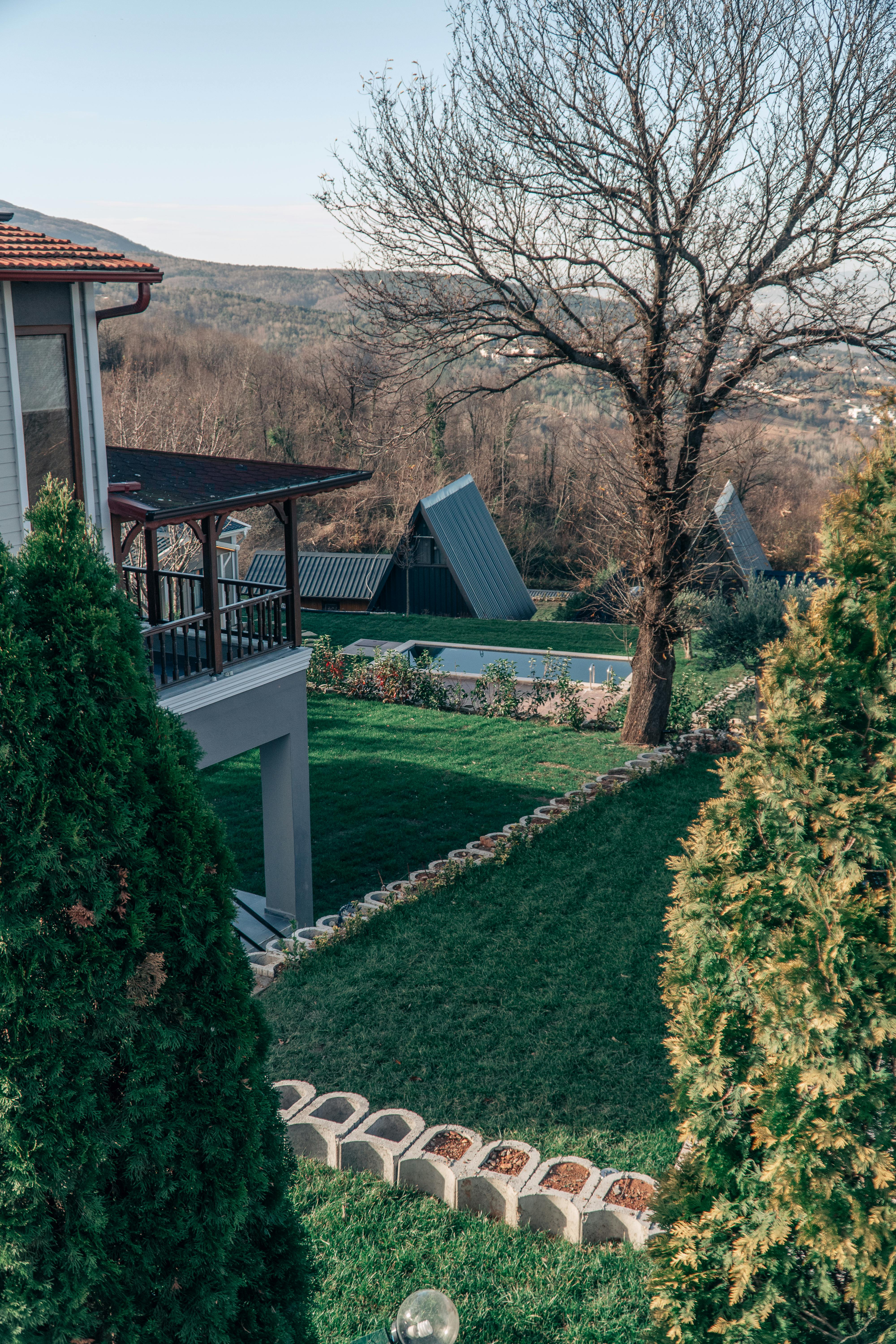 House Surrounded by Green Grass Below Clouds and Sky · Free Stock Photo