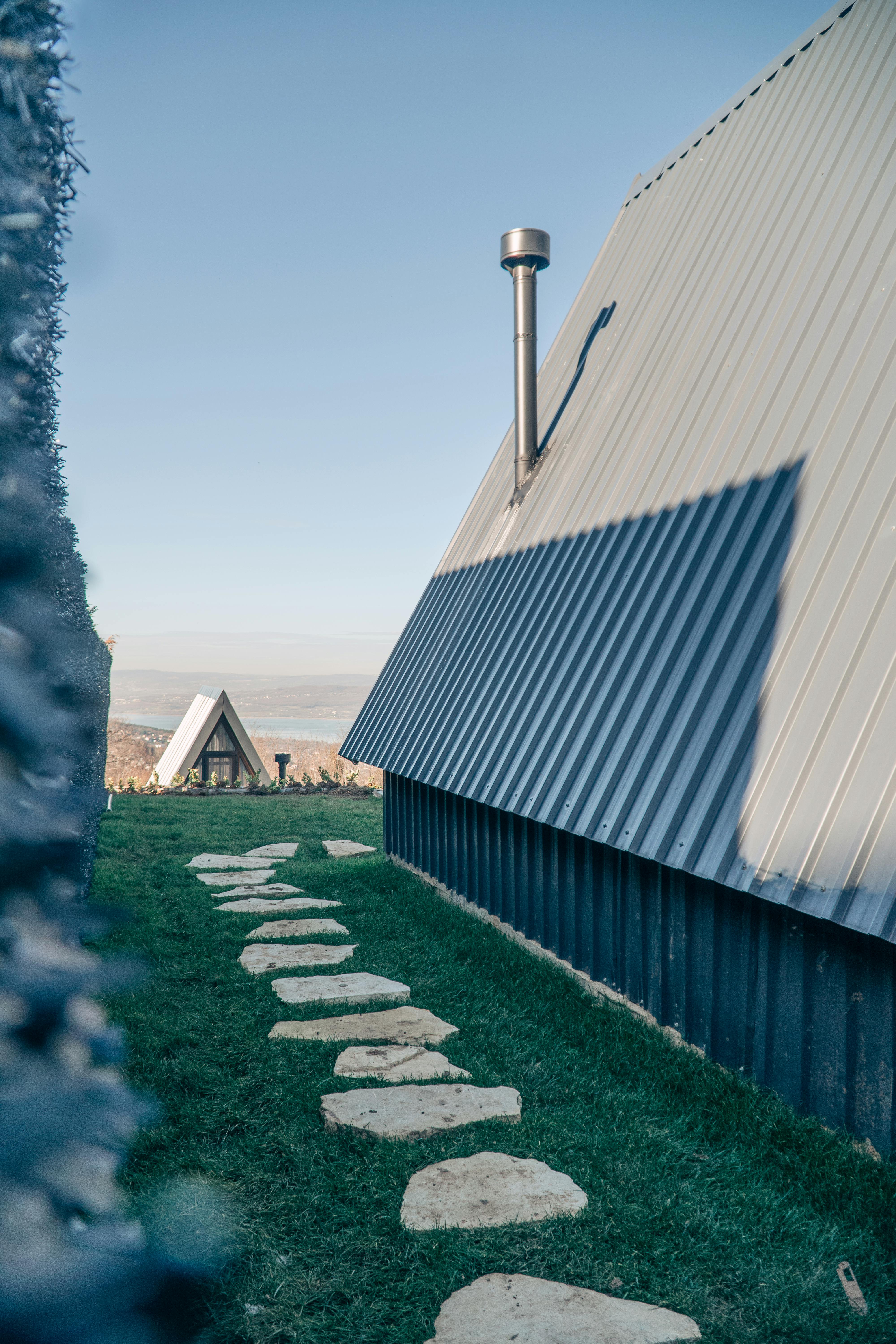 Stone Path between Small Vacation Homes with Steep Roofs · Free Stock Photo
