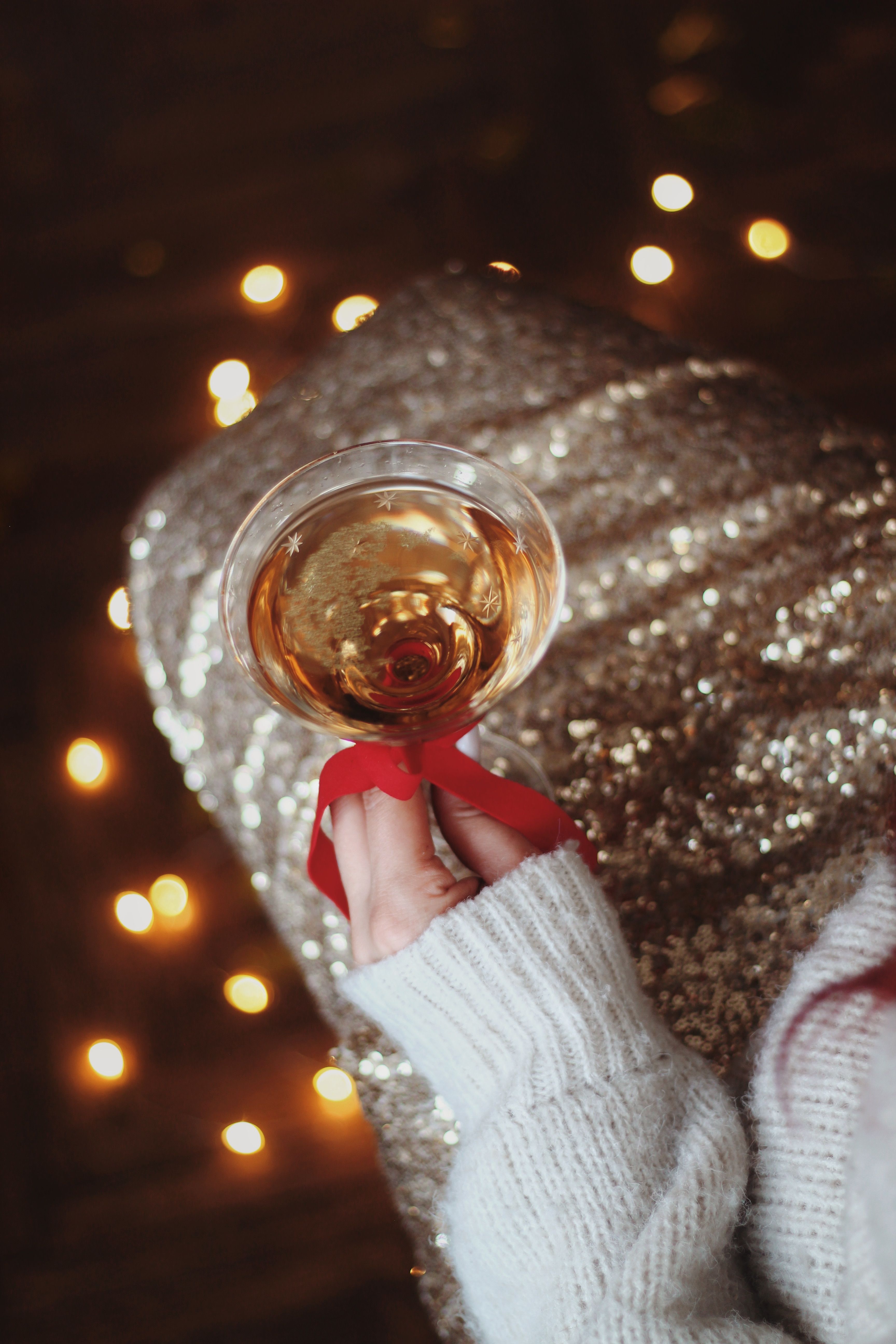 Woman in Glistening Dress With Champagne Glass · Free Stock Photo