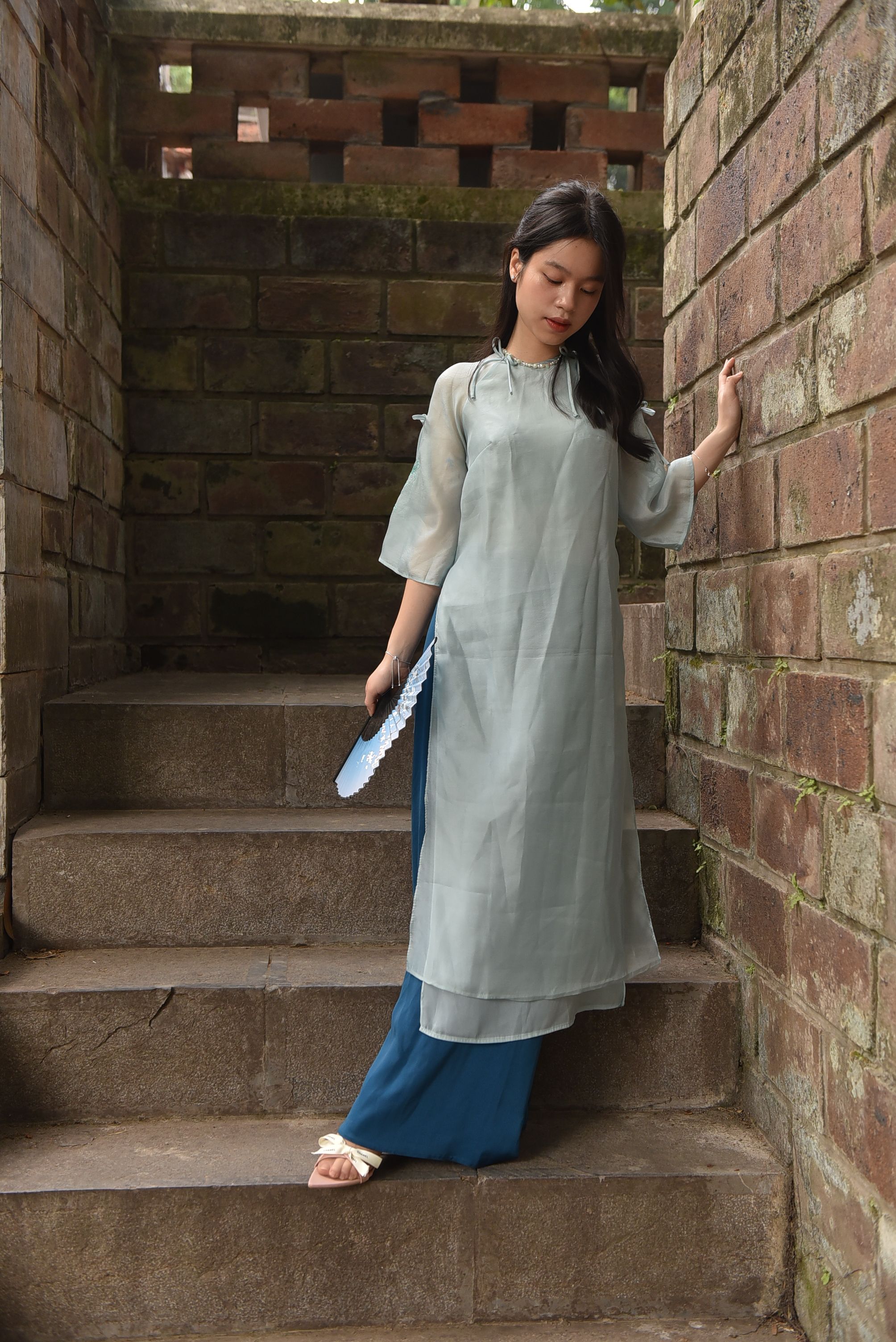 Young Model in Blue Ao Dai Walking Down the Stairs · Free Stock Photo