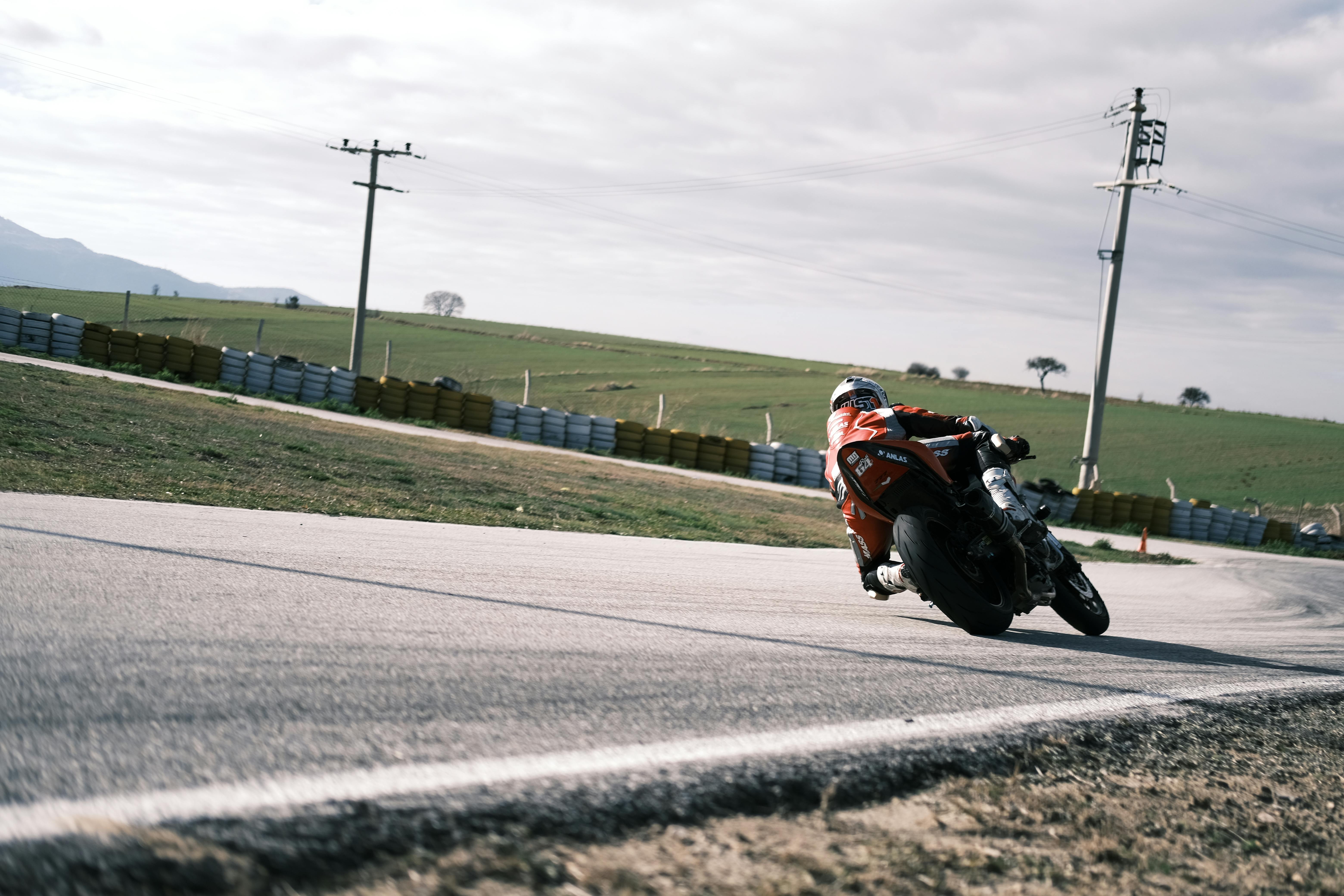 Motorcyclist Leaning on a Tight Turn of the Race Track · Free Stock Photo