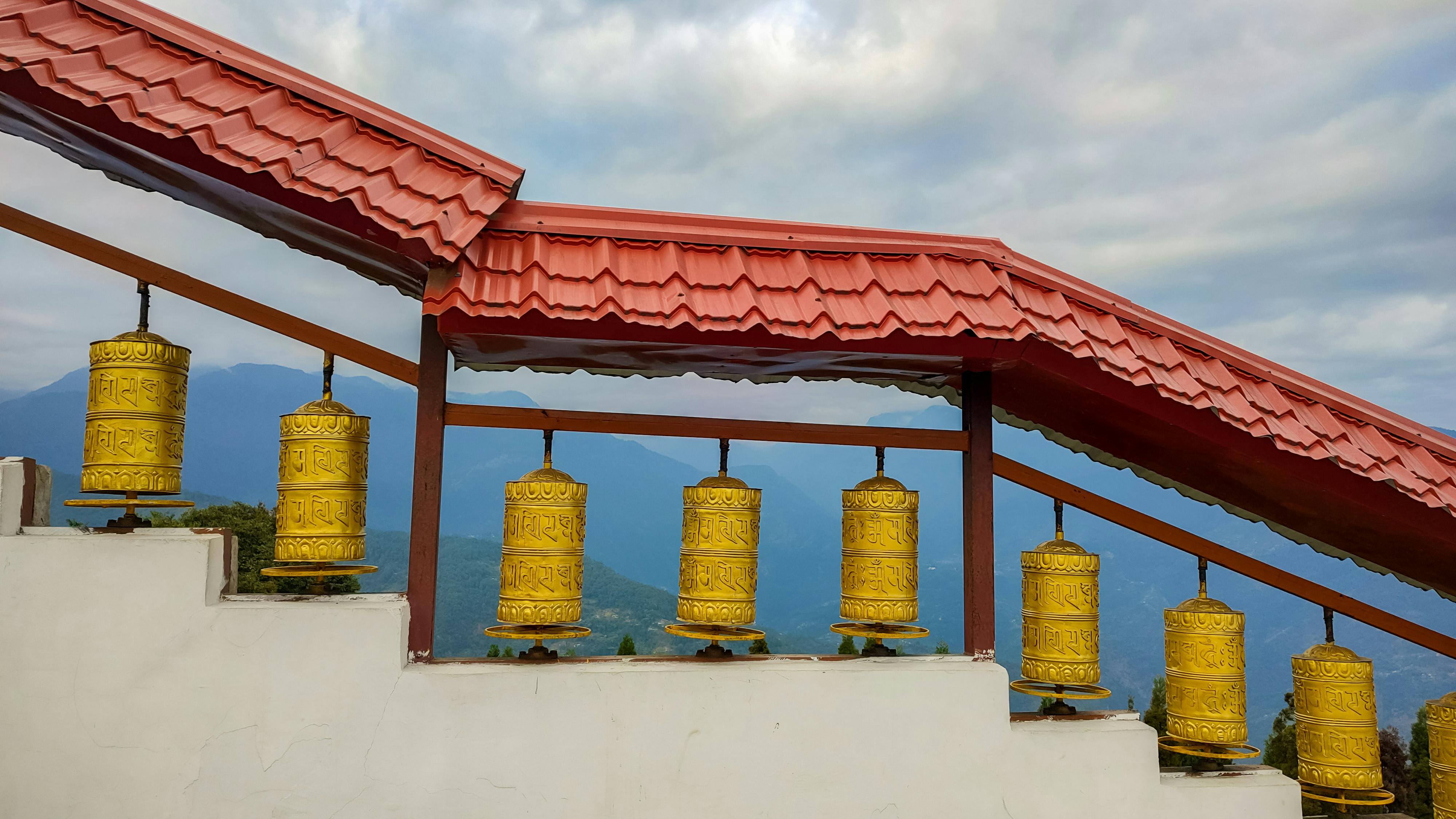 Golden Prayer Wheels in a Mountain Buddhist Monastery · Free Stock Photo