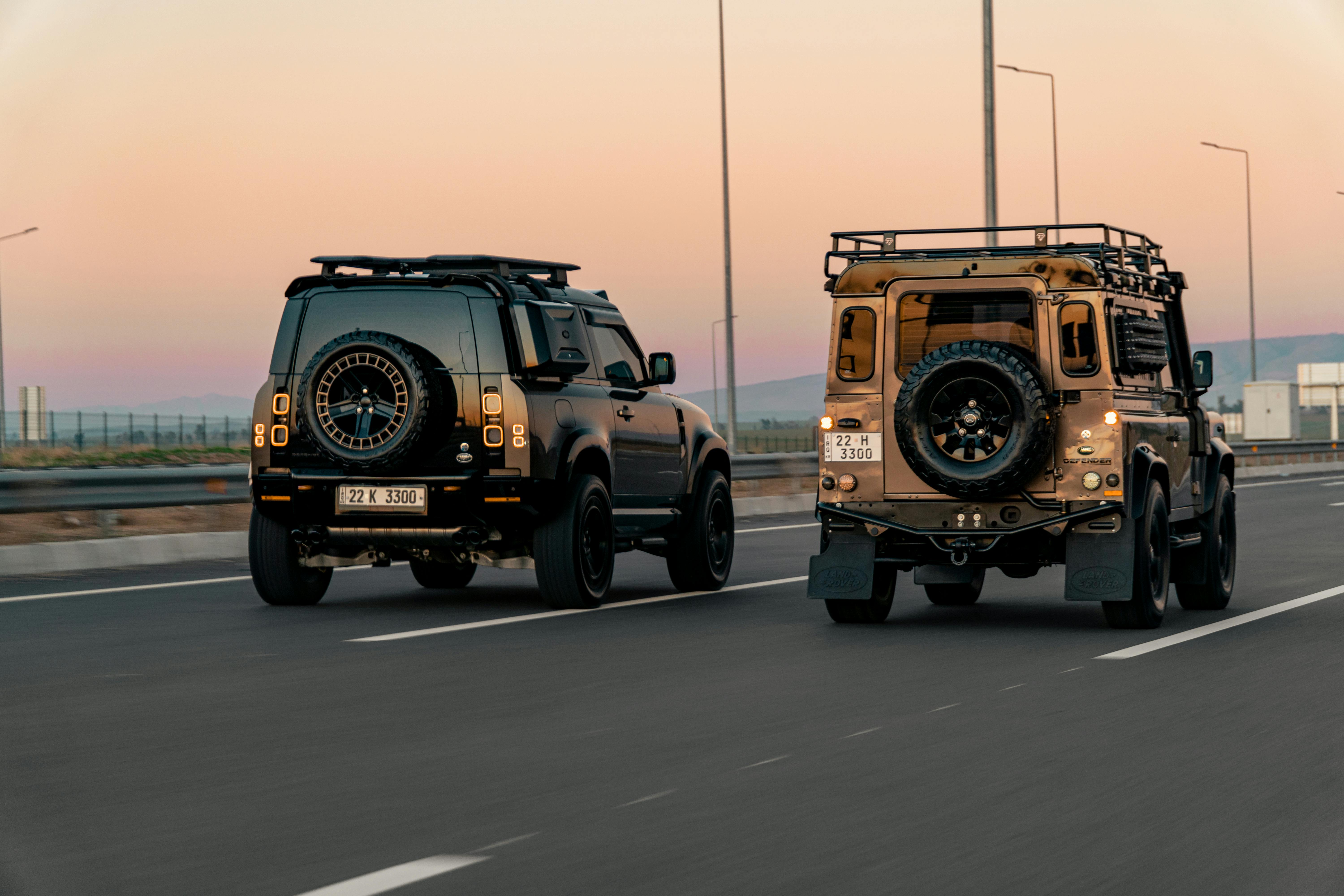 Land Rover Defenders on the Street at Sunset · Free Stock Photo
