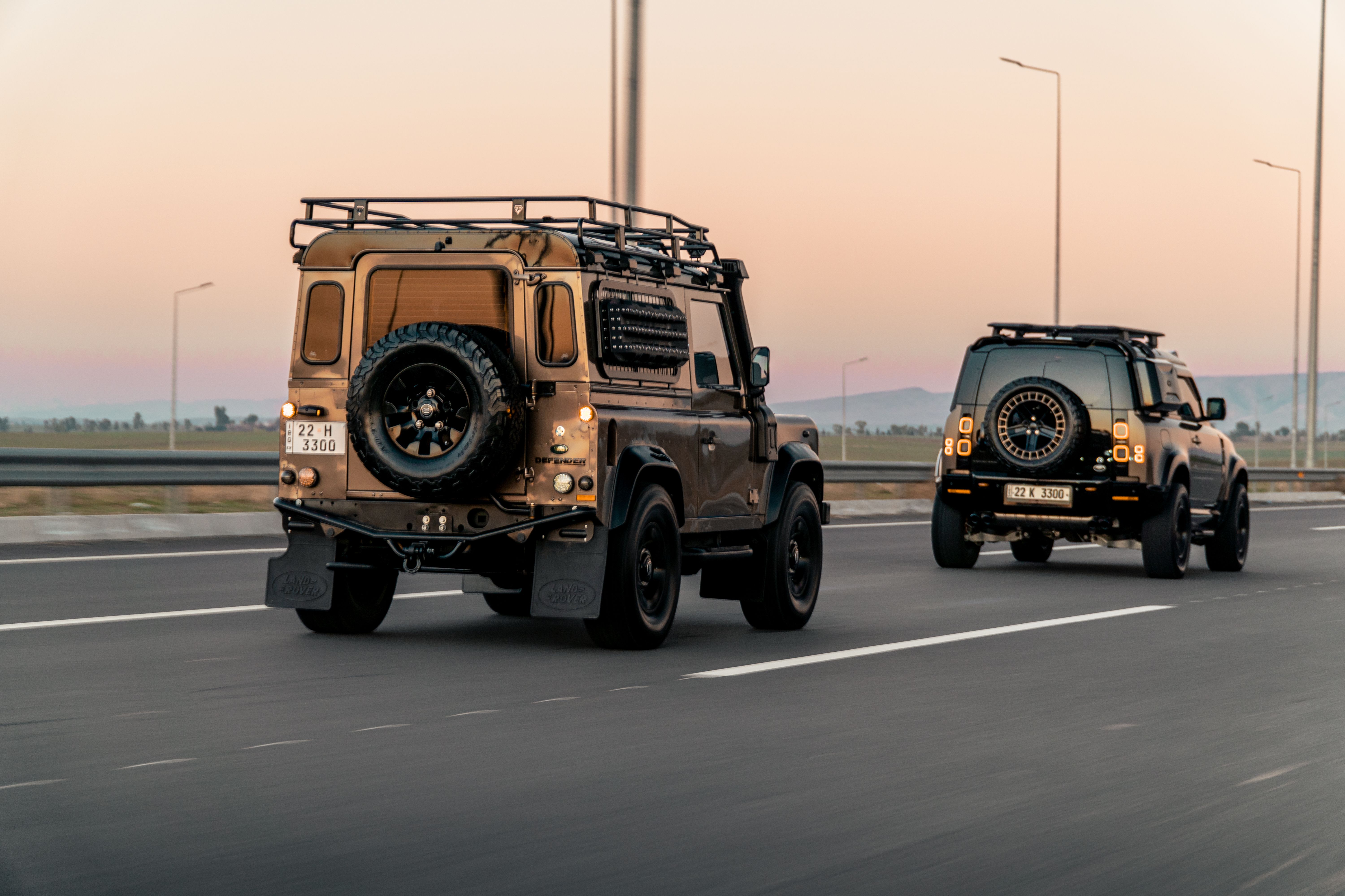 Land Rover Defenders on the Street at Sunset · Free Stock Photo