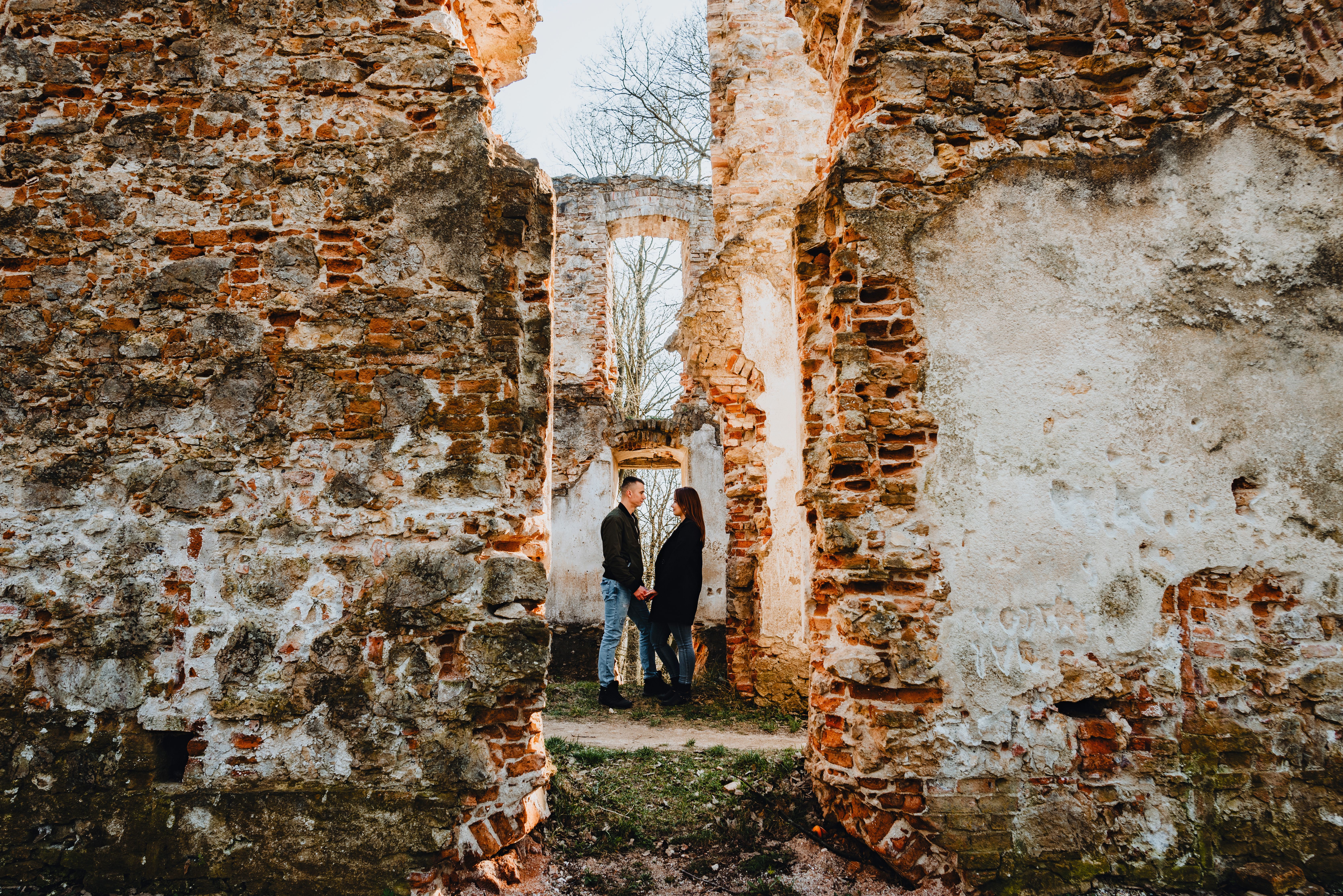 Couple Holding Hands in Ruins of Building · Free Stock Photo
