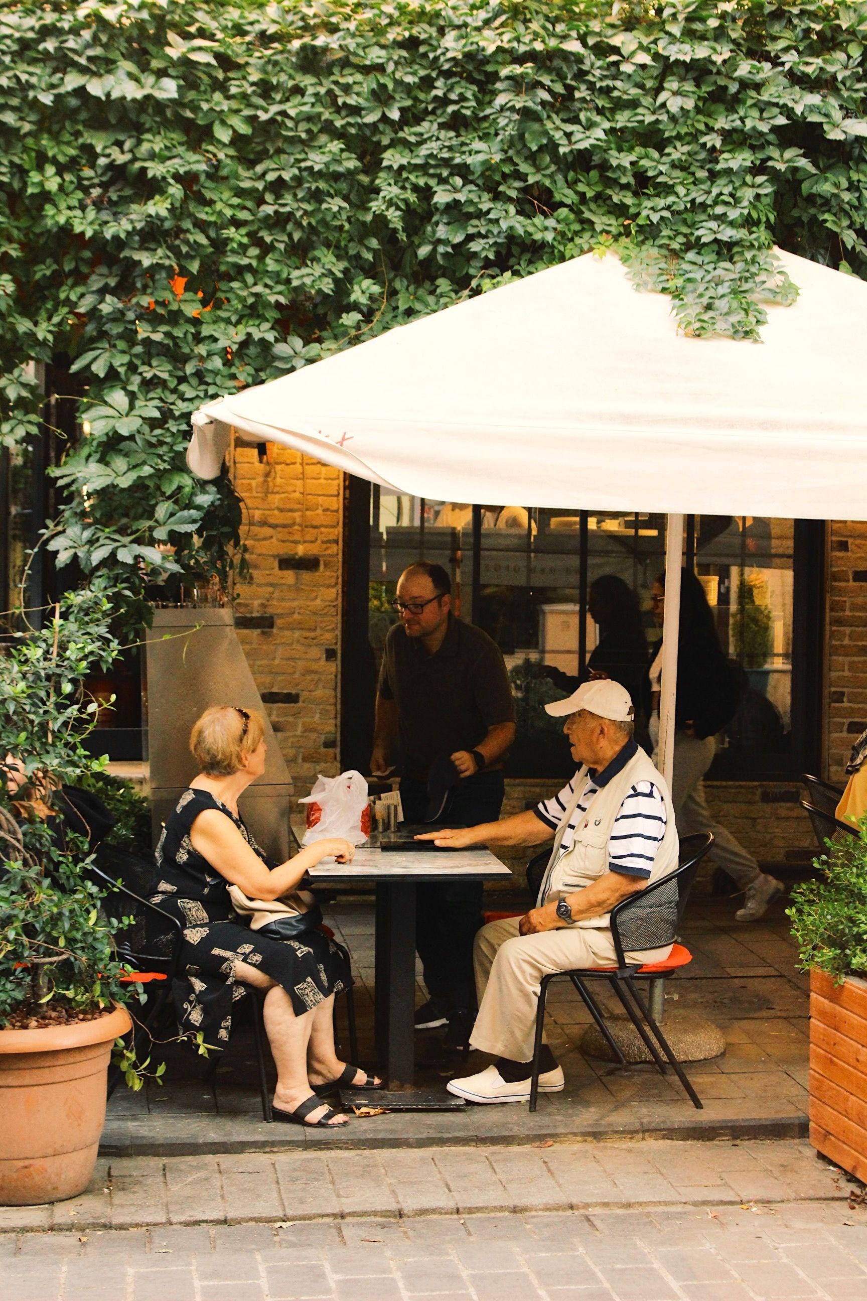 Senior Couple Sitting outside a Cafe · Free Stock Photo
