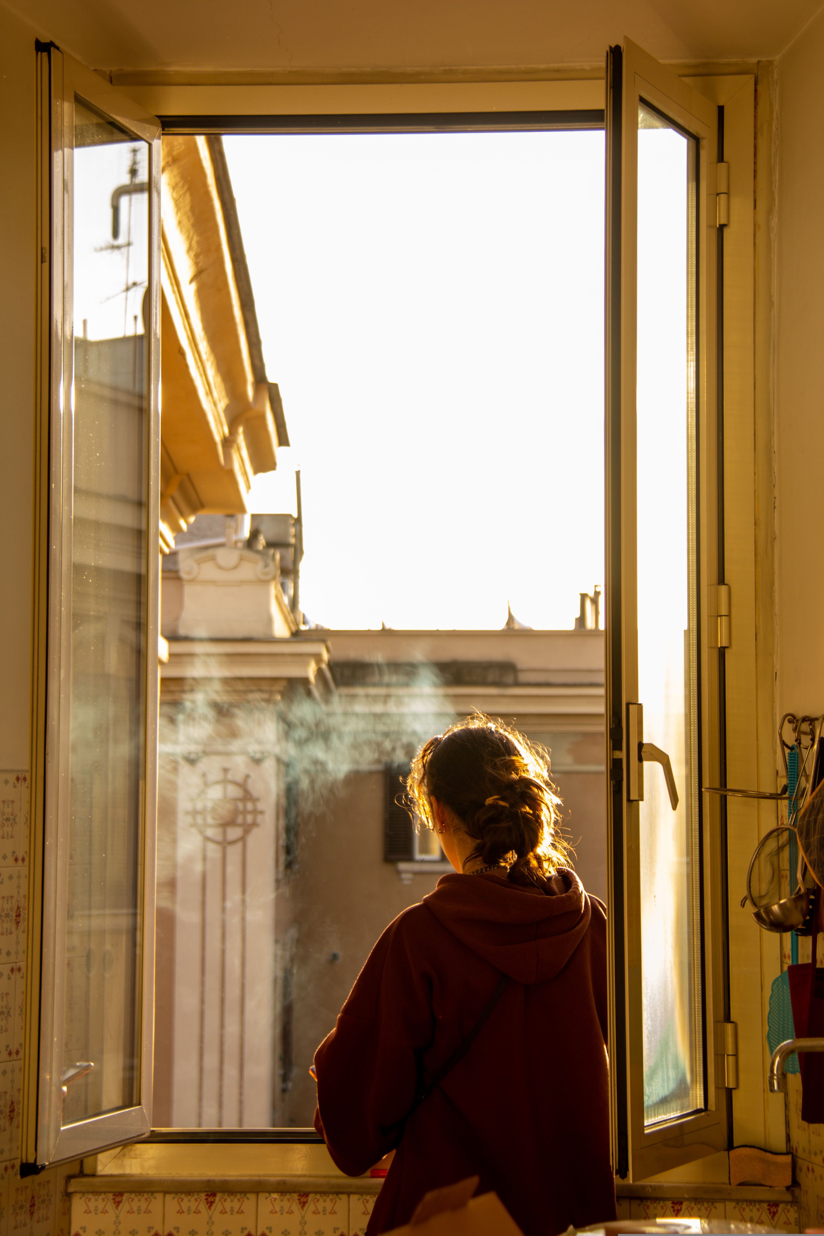 Woman Smoking in front of an Open Window · Free Stock Photo