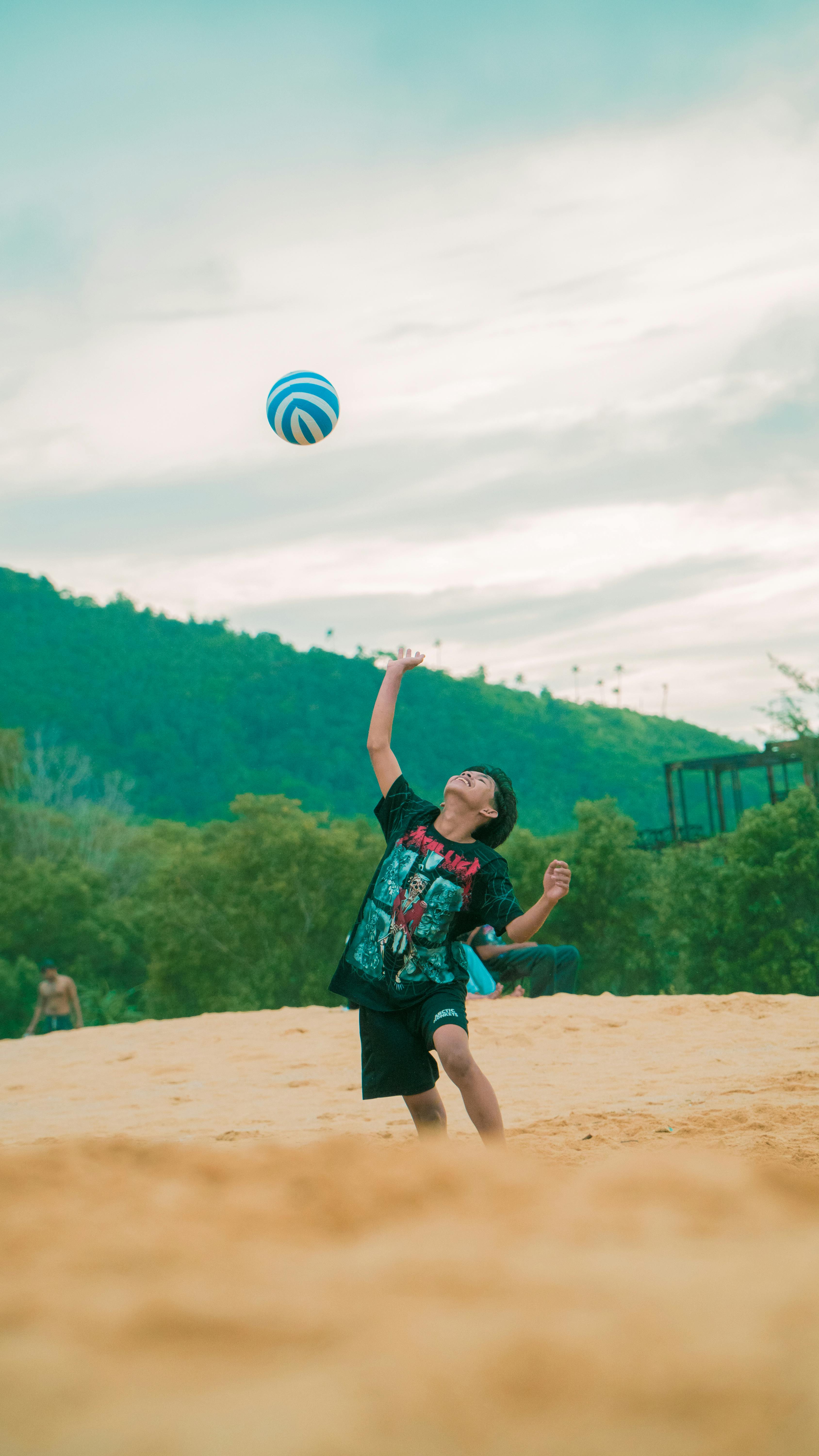 A Boy Throwing a Ball Outside · Free Stock Photo