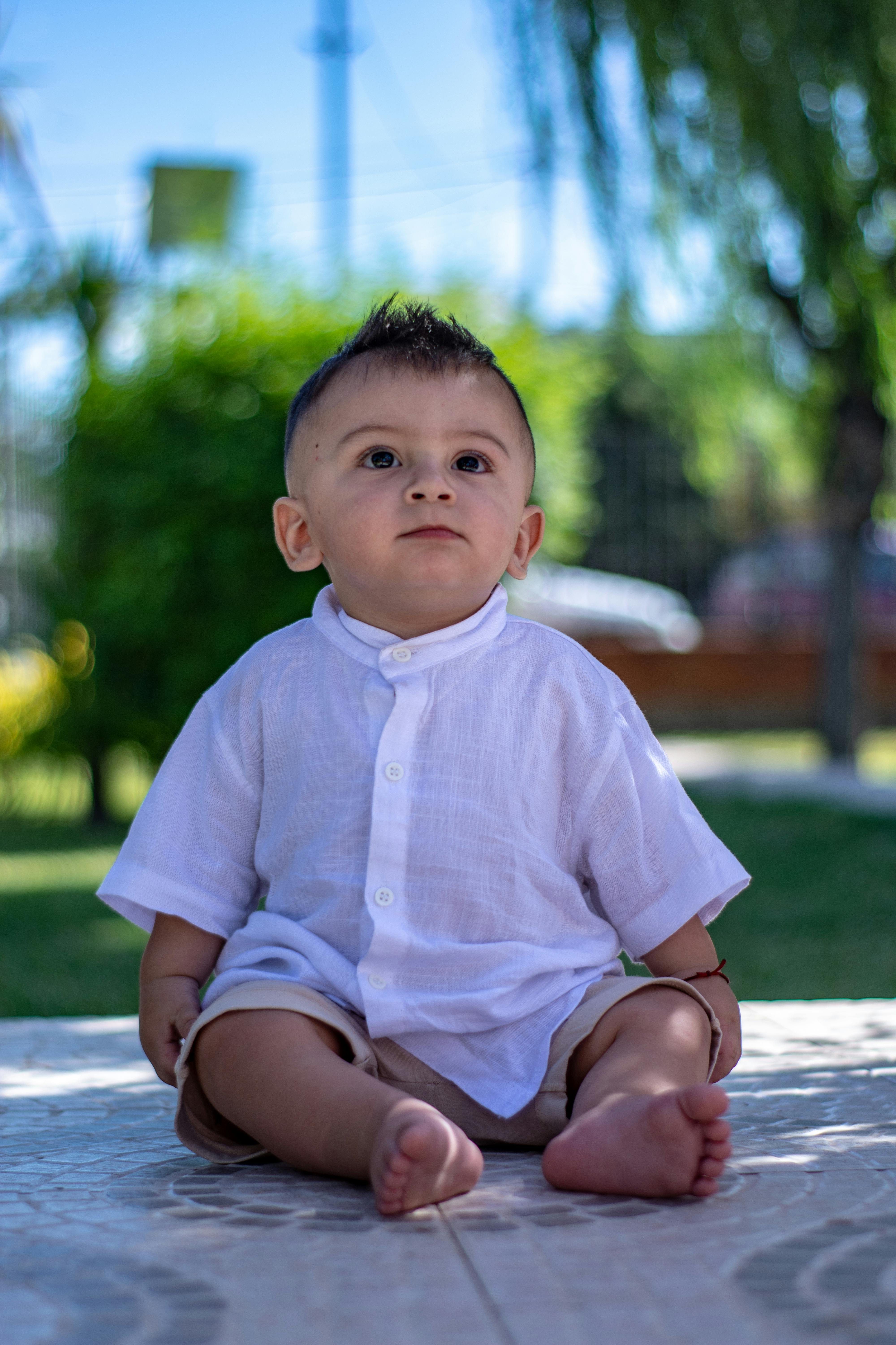 Child Model Sitting Outdoors · Free Stock Photo