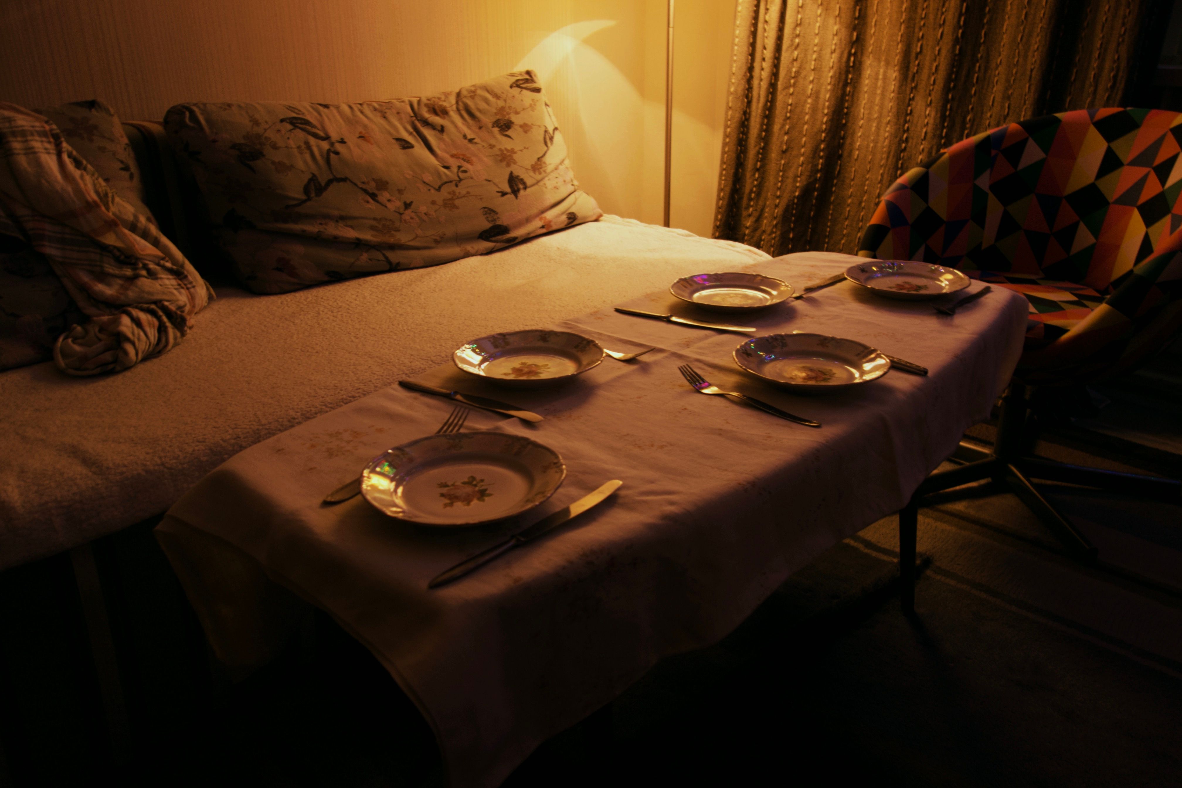 Plates on Table by Couch in Room · Free Stock Photo