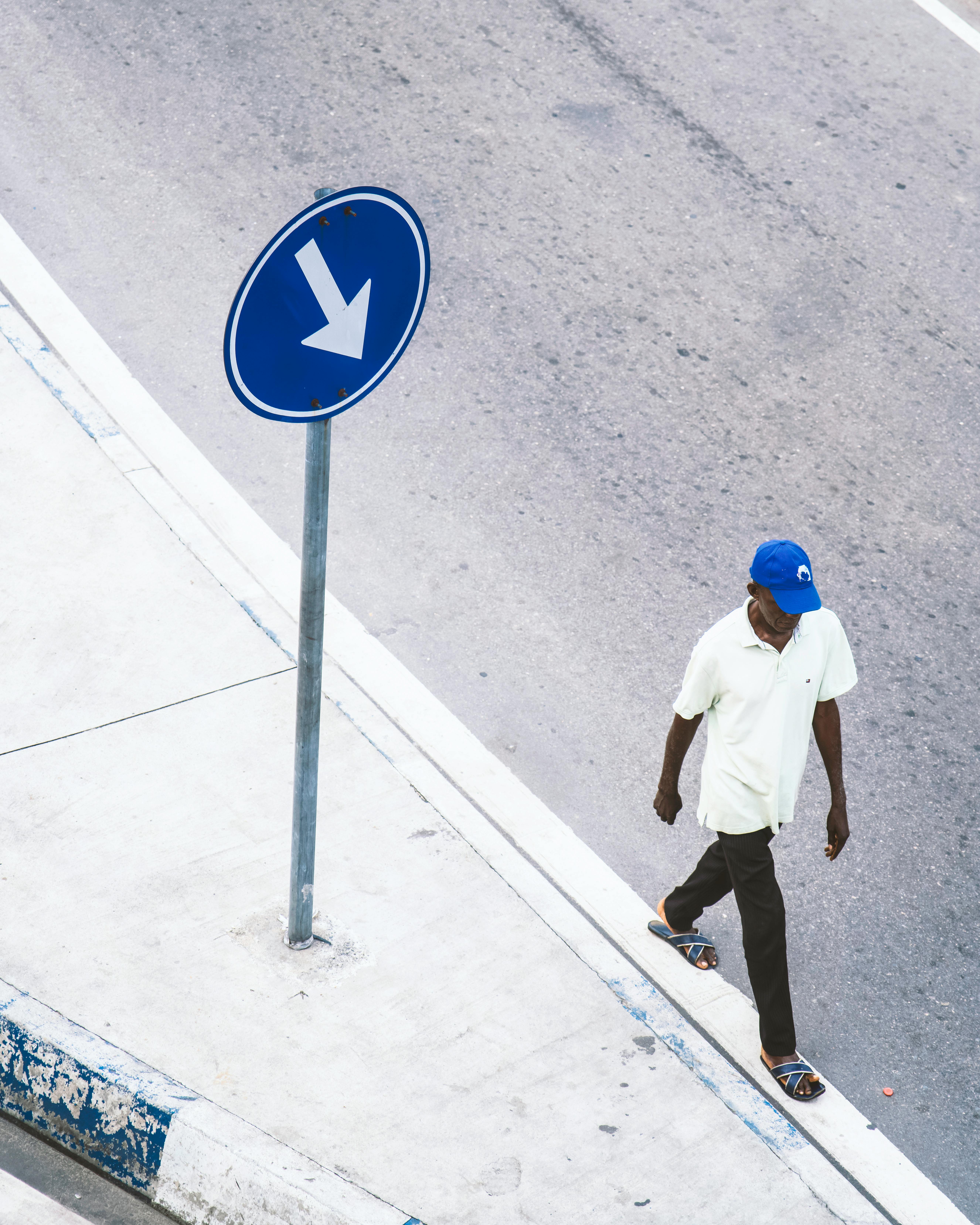 Top View of a Man Walking on the Sidewalk · Free Stock Photo